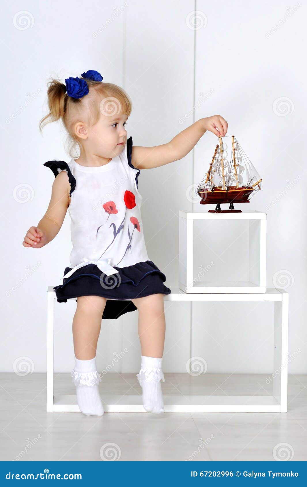 Little Girl Playing with Toy Boat in the Studio Stock Photo - Image of ...