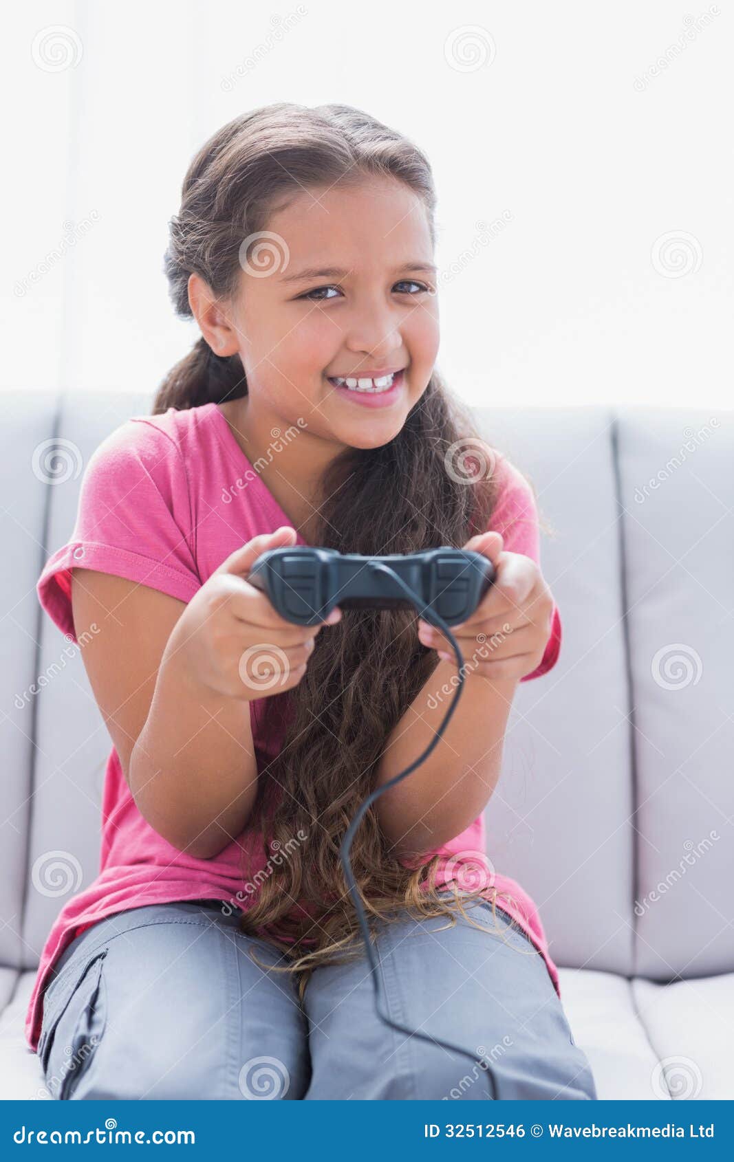 Little Girl Playing Video Game on Sofa Stock Photo - Image of ...
