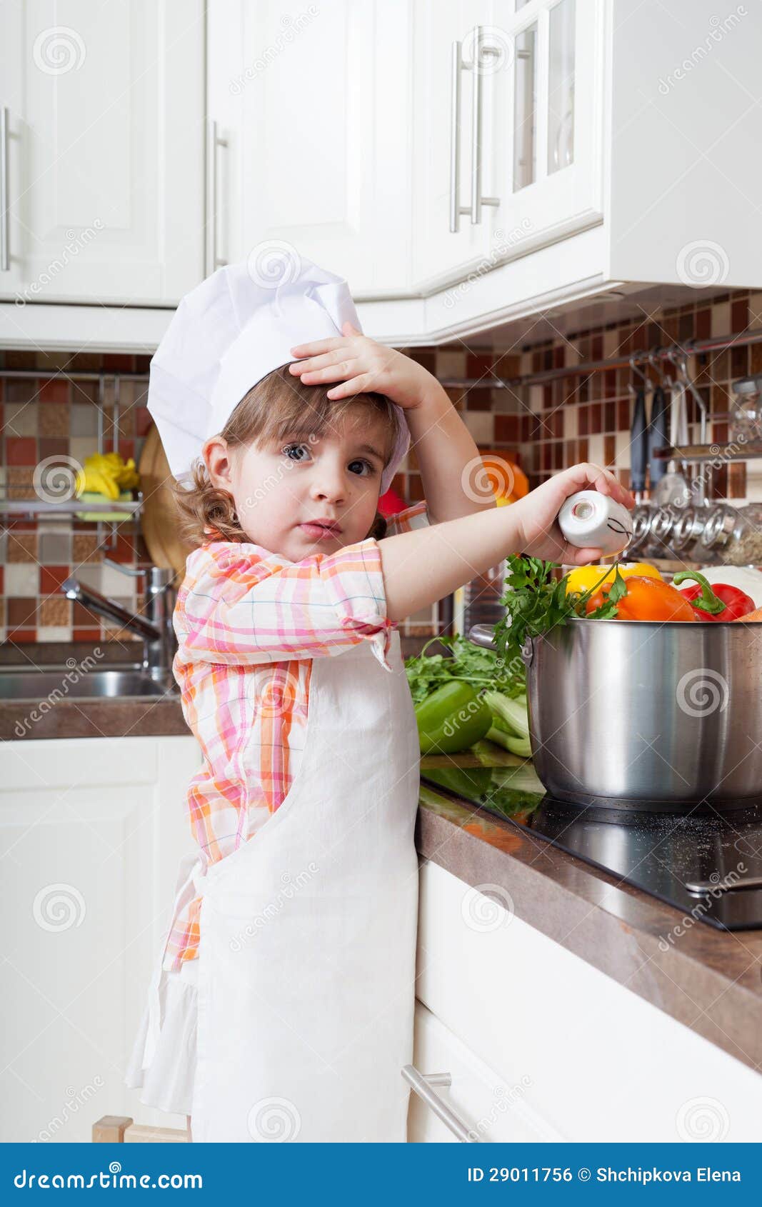 Little girl plays the cook stock photo. Image of girl - 29011756