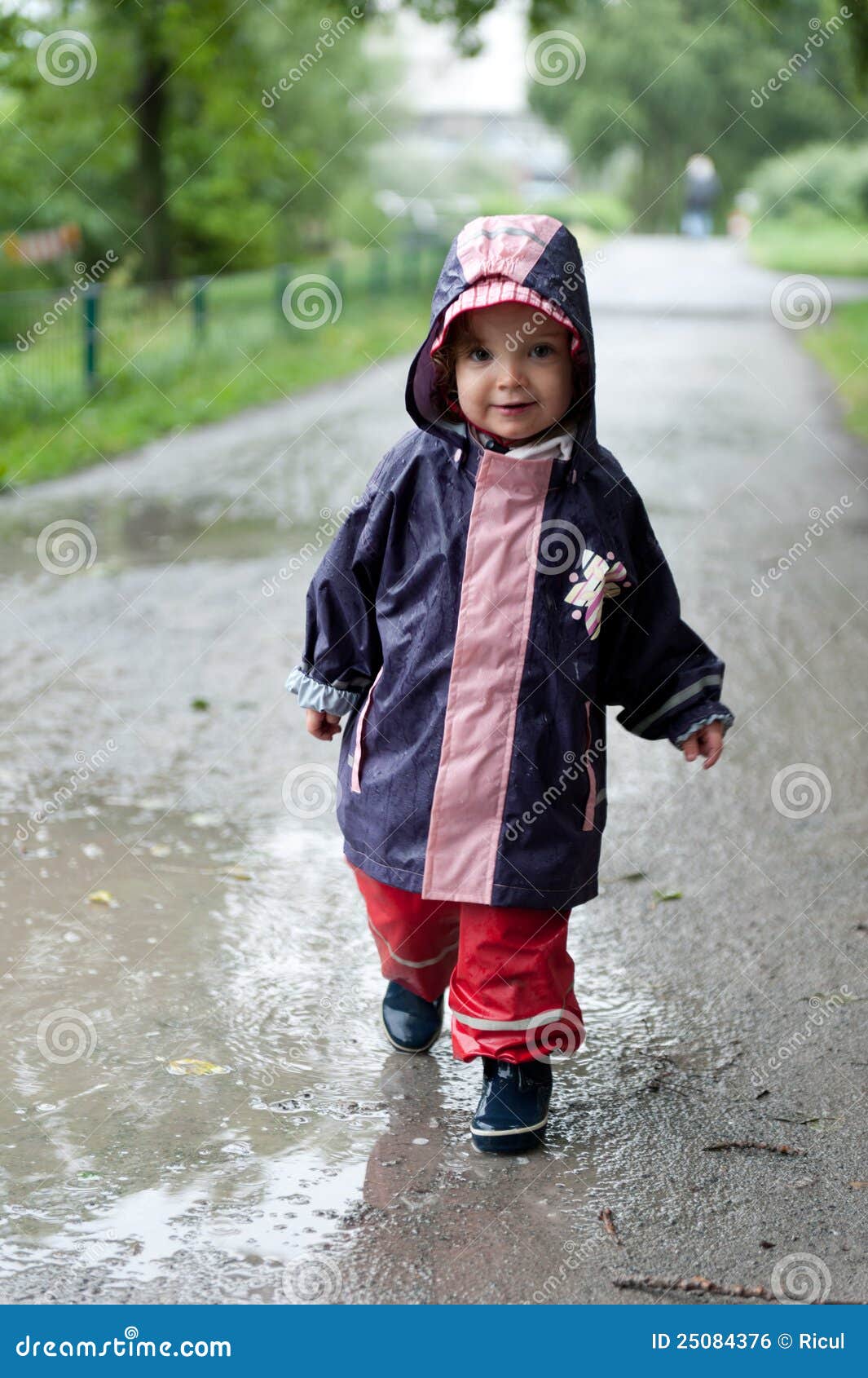 Little girl in a puddle stock photo. Image of lough, river - 25084376