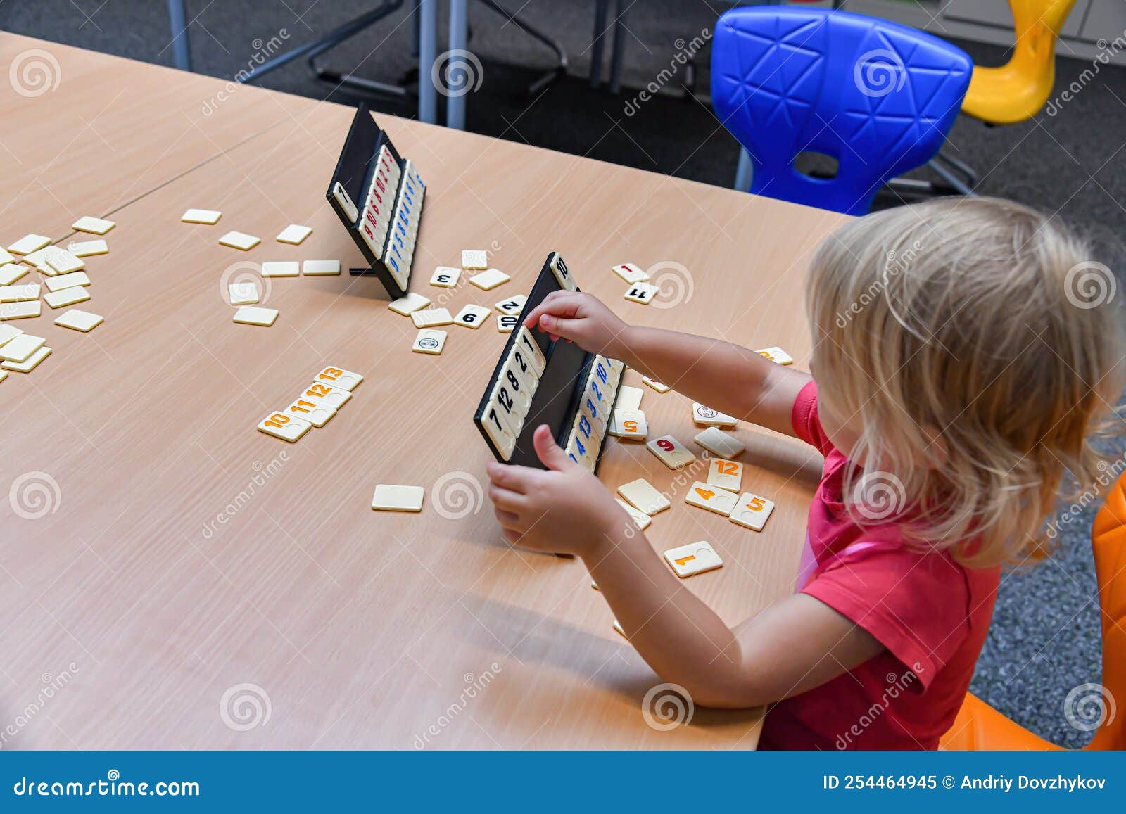 A Little Girl Puts the Chips with Numbers in Order Stock Image - Image ...
