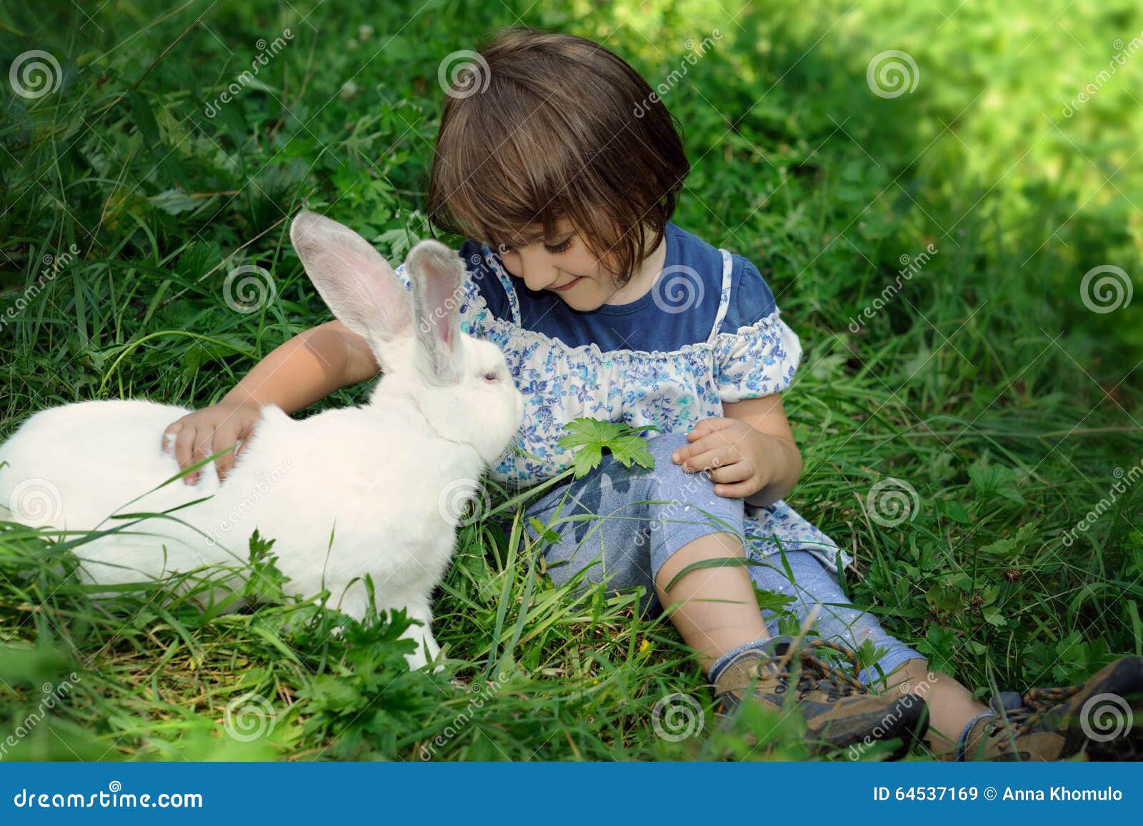 Little girl with rabbit stock image. Image of green, outdoor - 64537169
