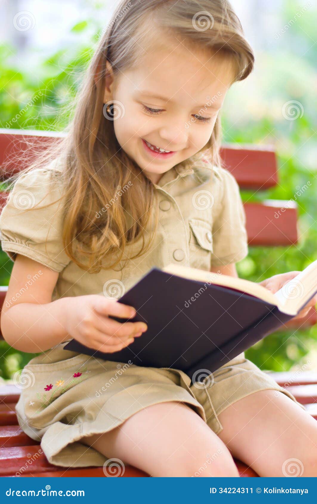 Little Girl is Reading a Book Stock Image - Image of holding, little ...