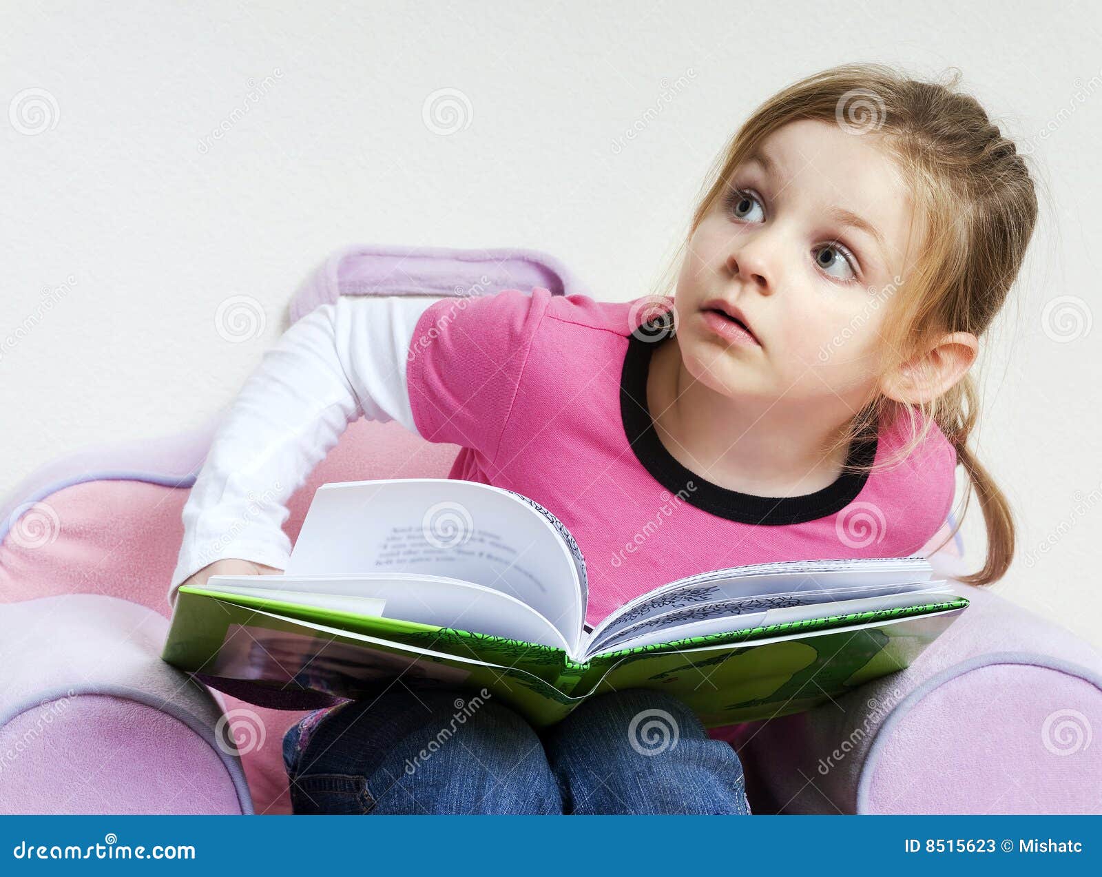 Little Girl Reading a Book and Looking Up Stock Image - Image of ...