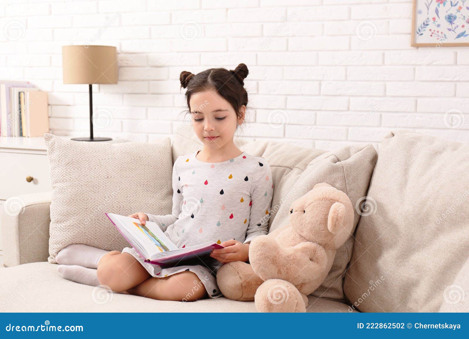 Little Girl Reading Book on Sofa Stock Photo - Image of book, leisure ...