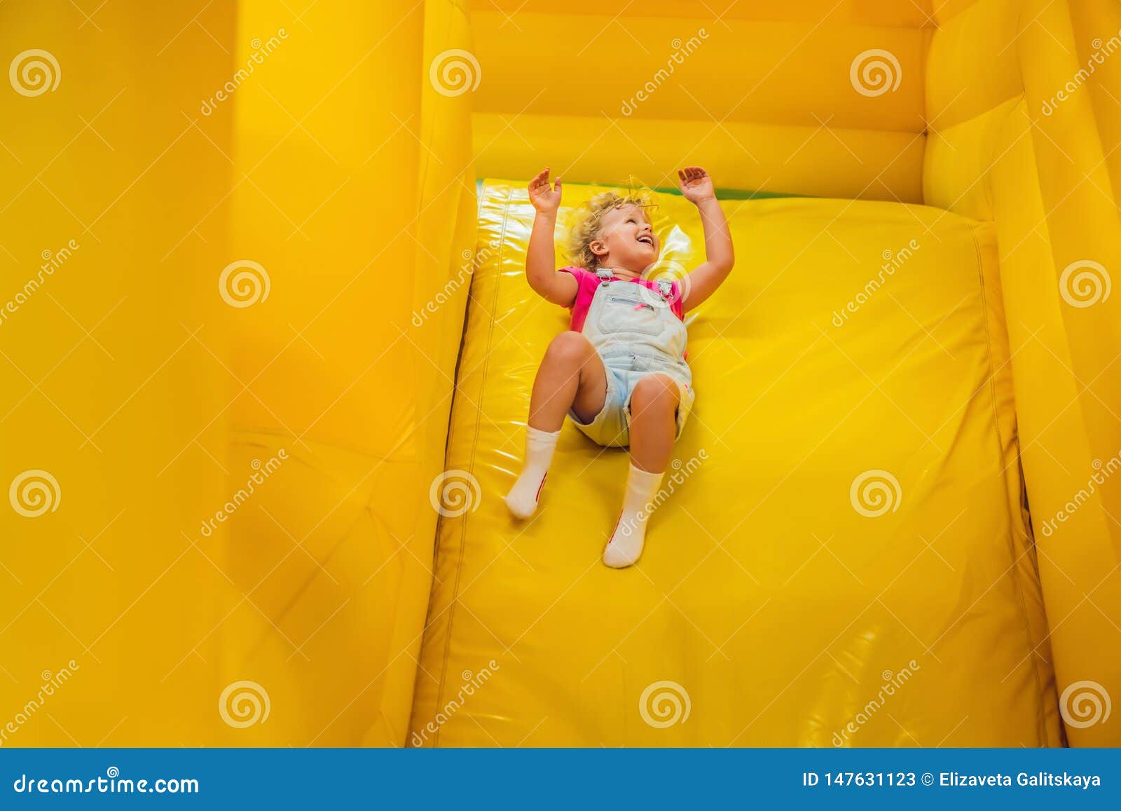 Little Girl Ride from an Inflatable Slide Stock Image - Image of ...