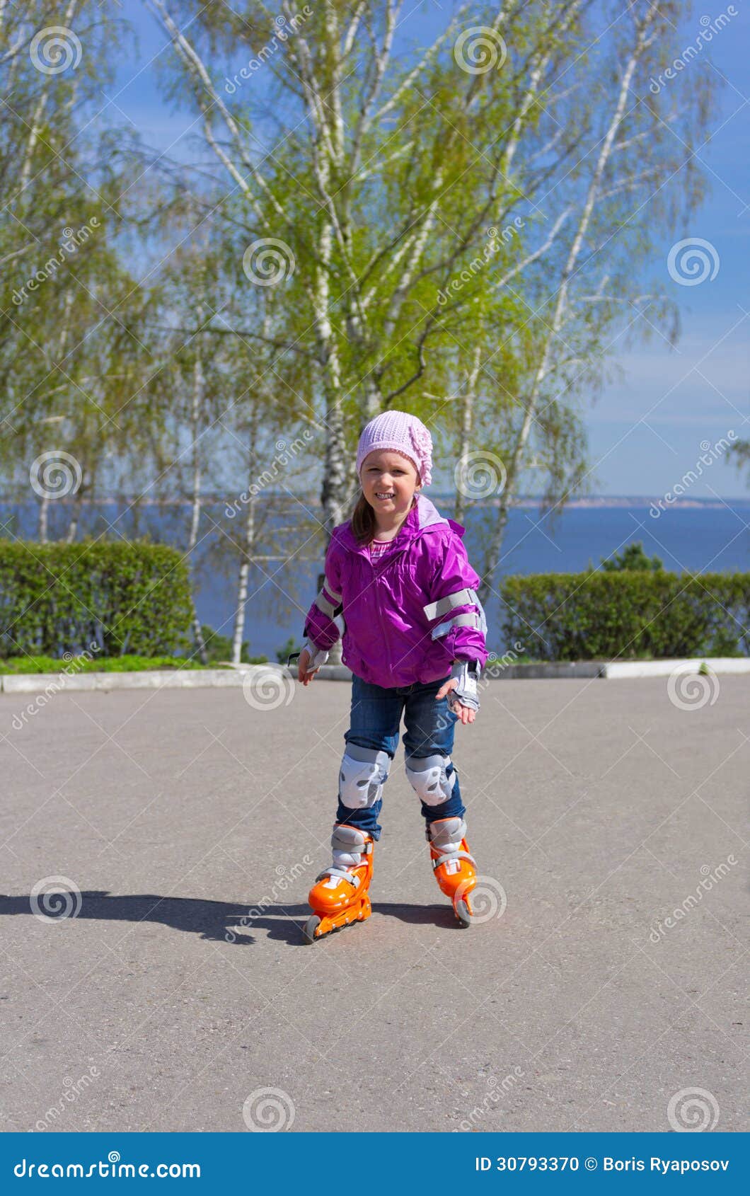 Little Girl Rides Roller Skates Stock Photo - Image of face, outdoors ...