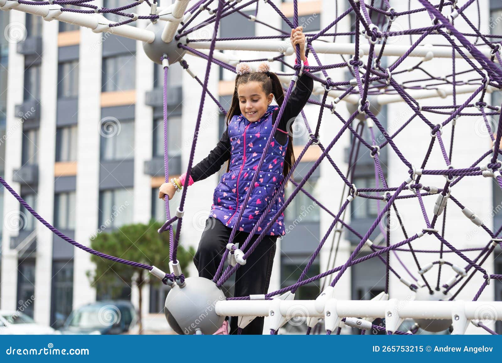 Little girl in a rope maze stock image. Image of amusement - 265753215