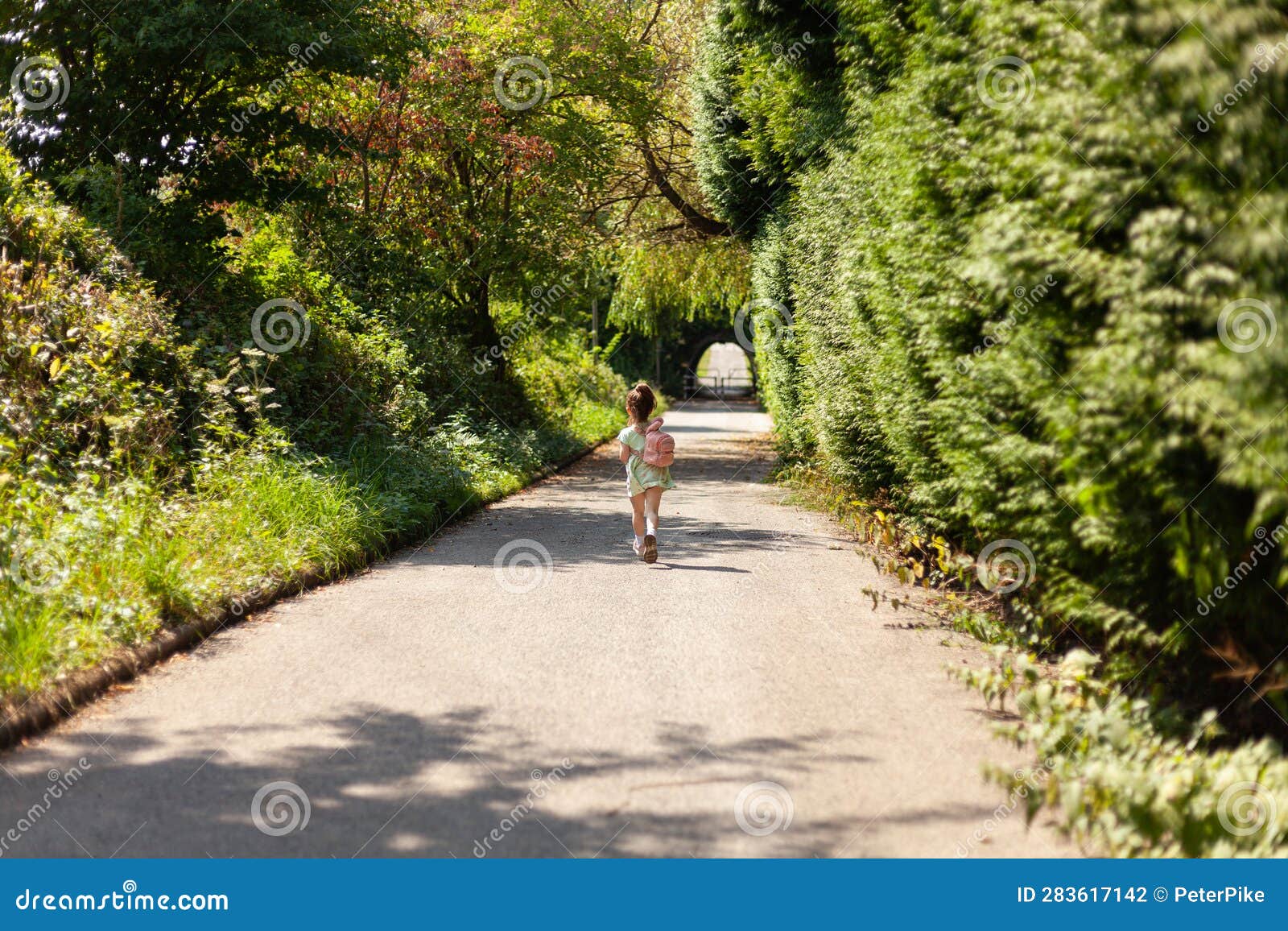 Little Girl Running on a Path in the Park on a Sunny Day Stock Photo ...