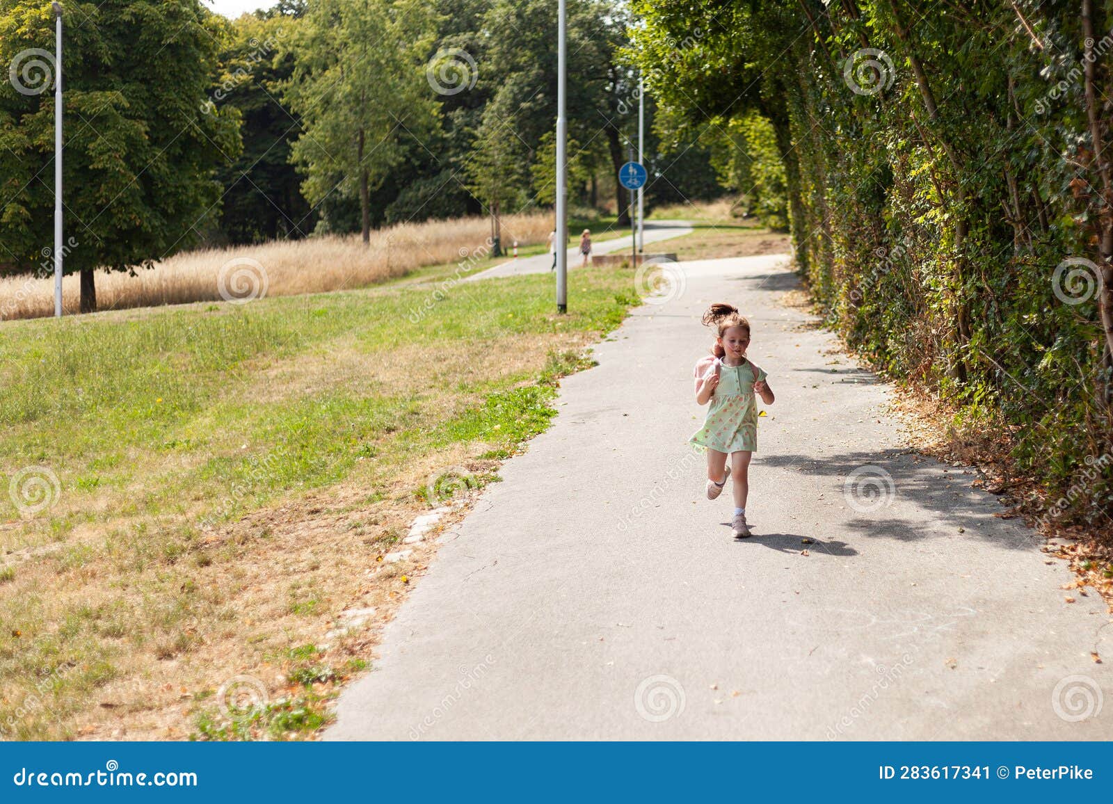 Little Girl Running on a Path in the Park on a Sunny Day Stock Image ...