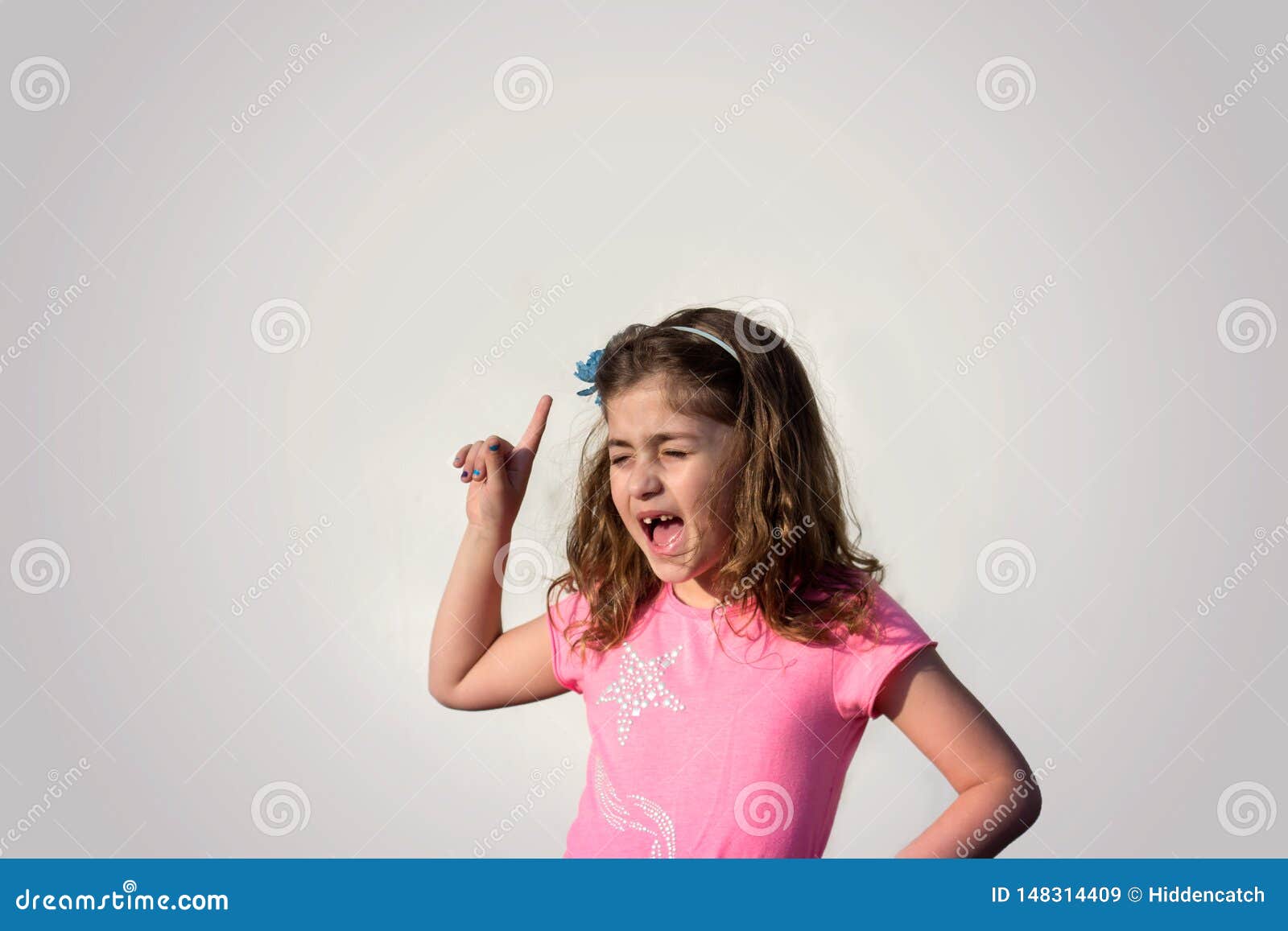 Little Girl Screaming and Pointing Her Finger Against Gray Background ... Little Girl Screaming and Pointing Her Finger Against Gray Background ...