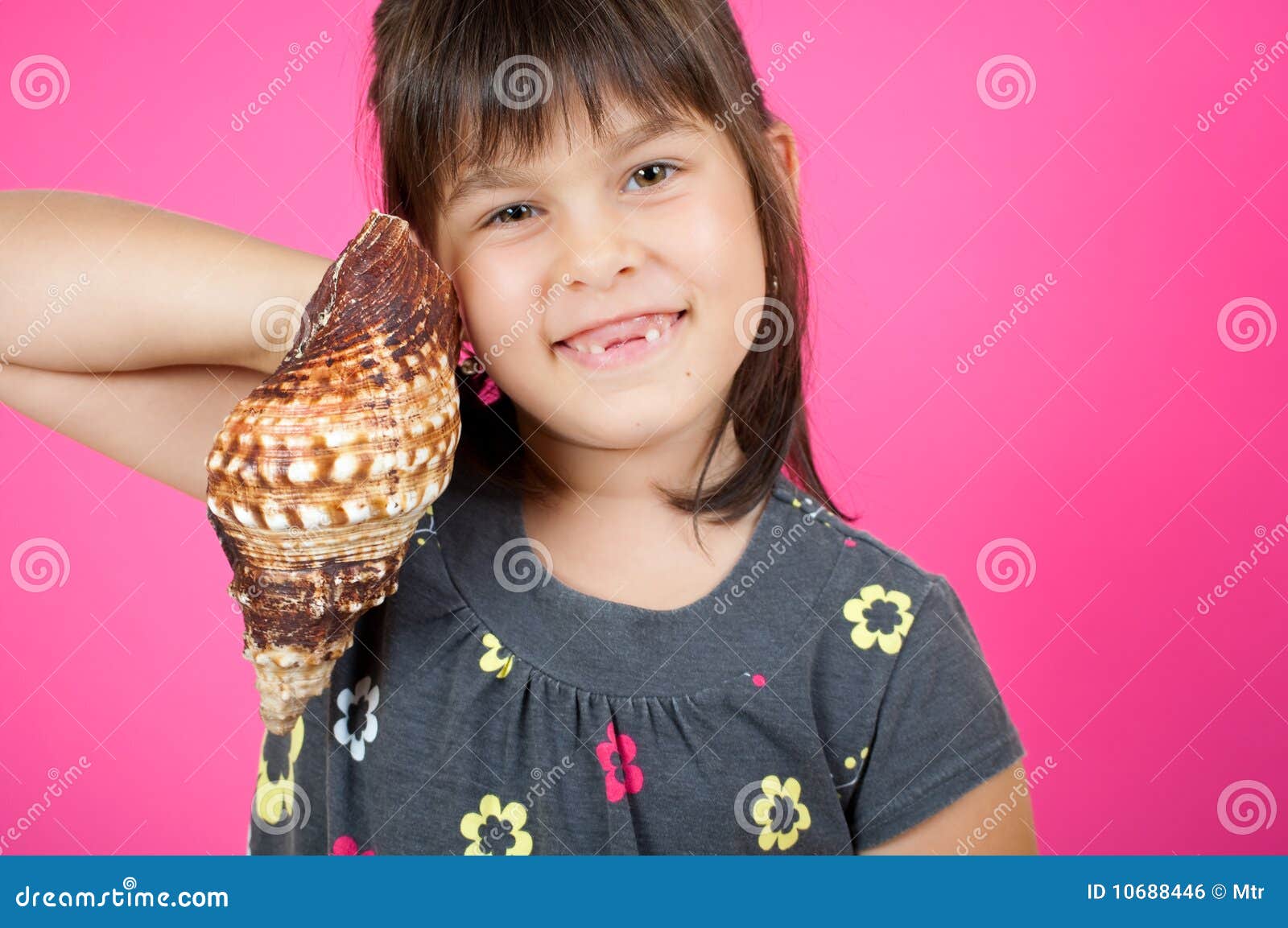 Little girl with a shell stock photo. Image of teeth - 10688446