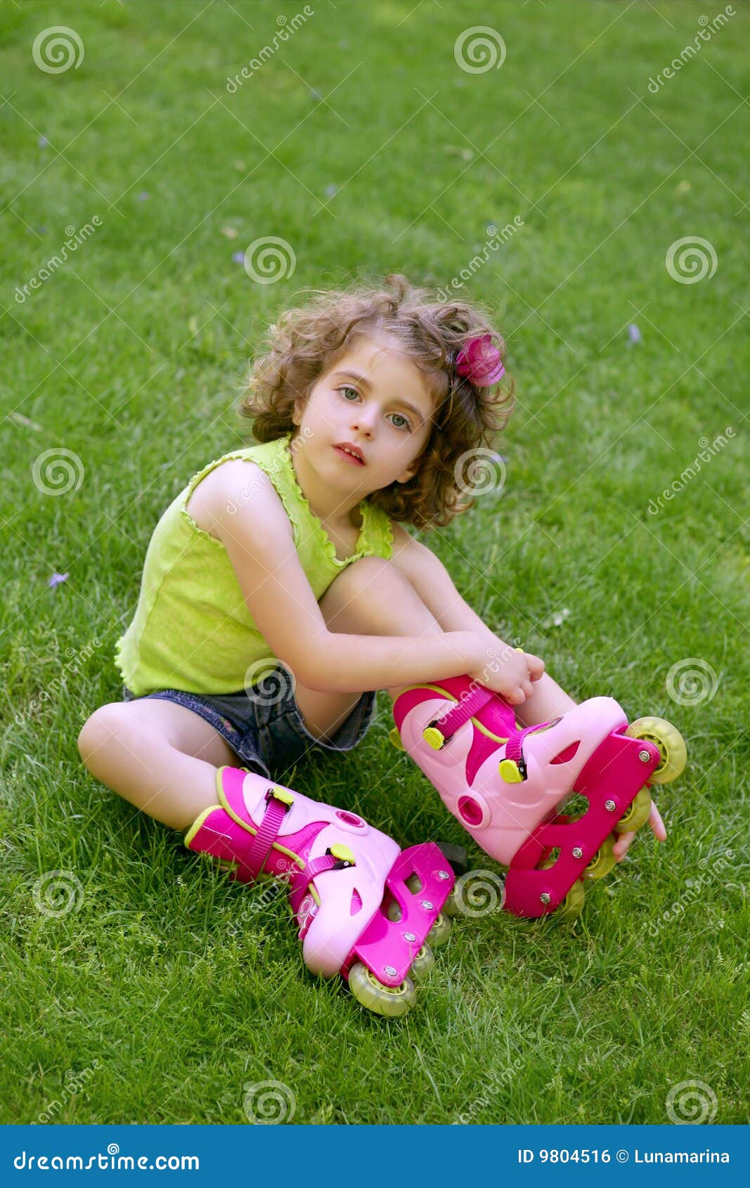 Little Girl Sit on the Grass with Roller Skates Stock Photo - Image of ...