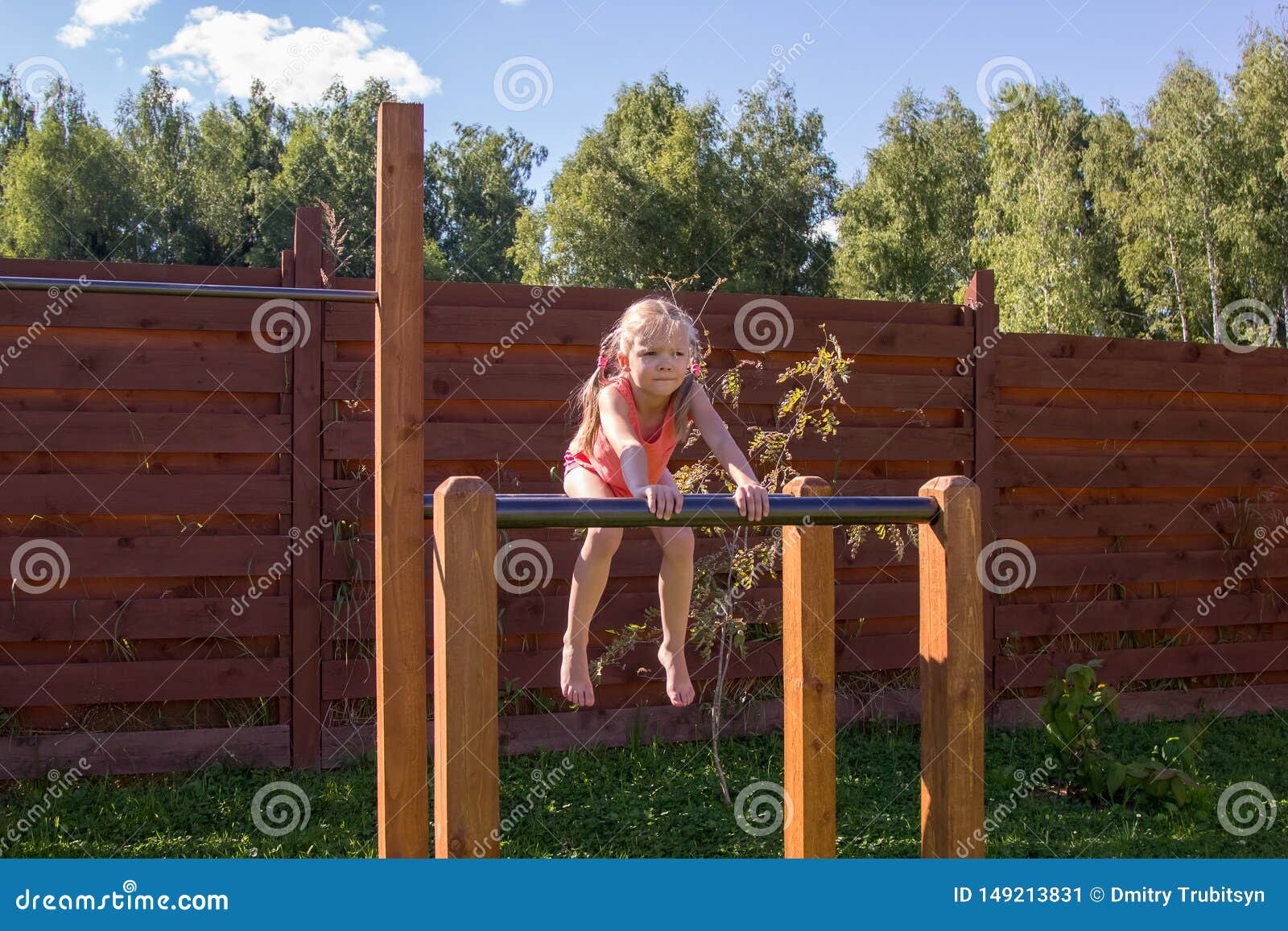 Little Girl Sitting on Parallel Bars Outside Stock Image - Image of ...