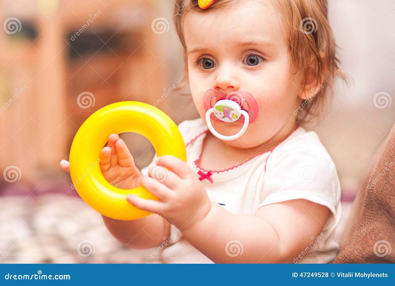 Little Girl Sitting Playing with a Toy Ring. Stock Photo - Image of ...