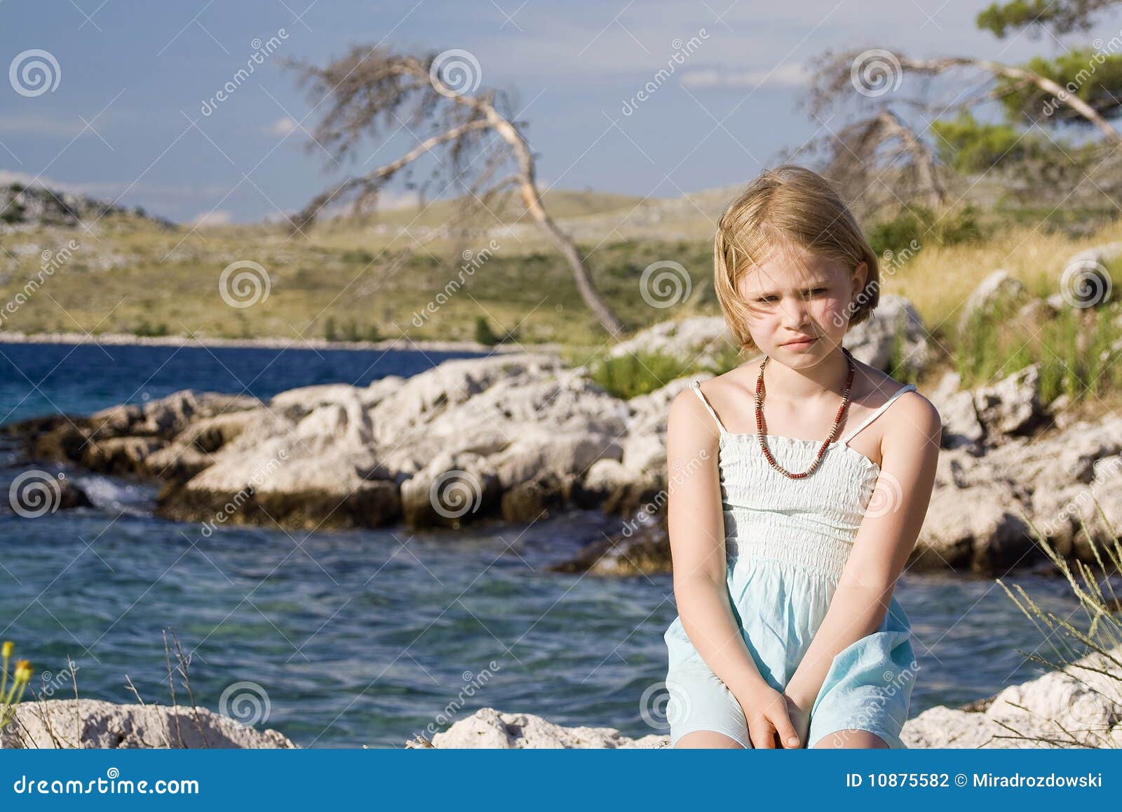 Little Girl Sitting on a Rocks Stock Photo - Image of face, portrait ...