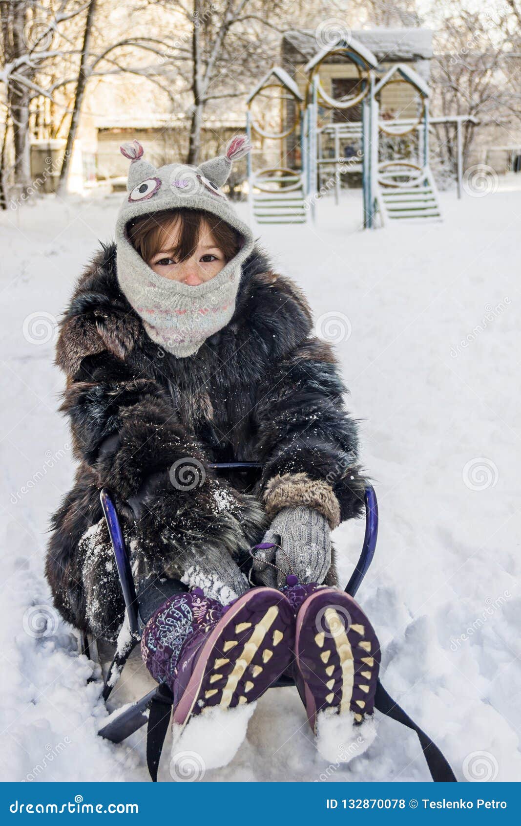 Little girl on sledge stock photo. Image of childhood - 132870078