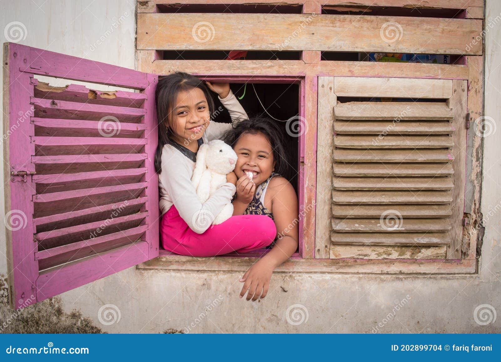 The Little Girl Smiles Behind the Old Window Editorial Stock Image ...