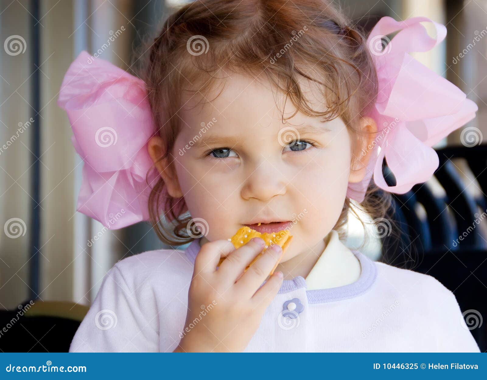 Little girl with snack stock image. Image of face, pink - 10446325