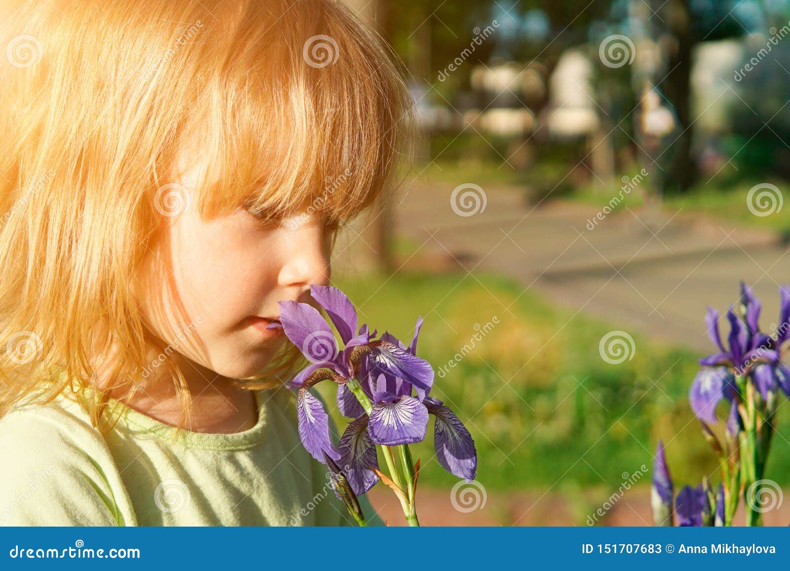 A Little Girl Sniffs Flowers. Stock Image - Image of bloom, holding ...
