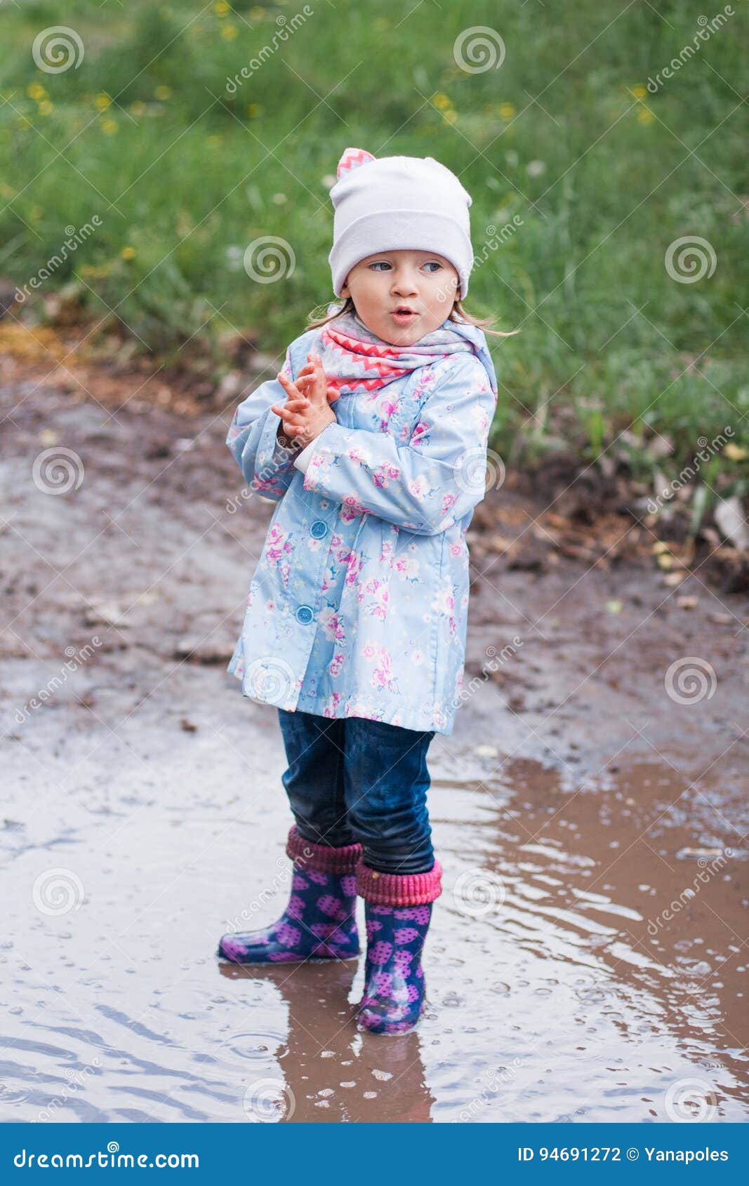 Little Girl Staying in the Puddle and Looking at the Right Stock Photo ...