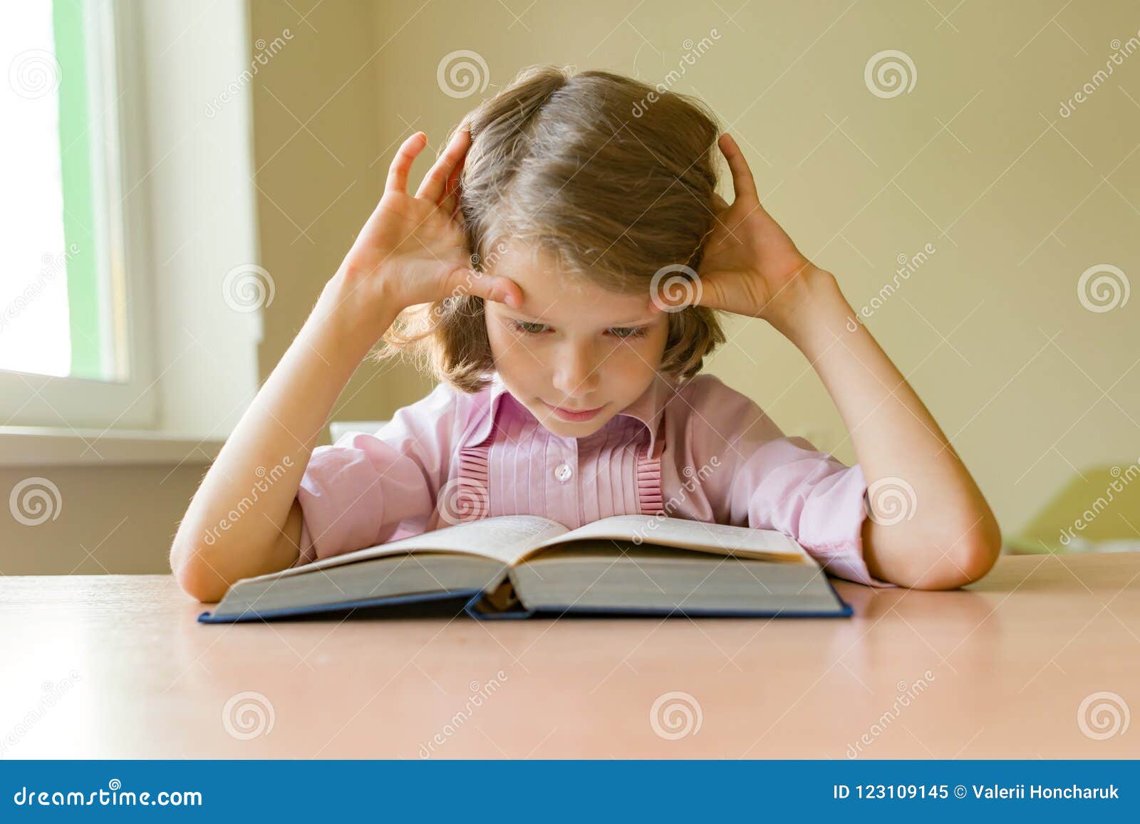 Little Girl Student Sits at a Desk with Book. School, Education ... Little Girl Student Sits at a Desk with Book. School, Education ...