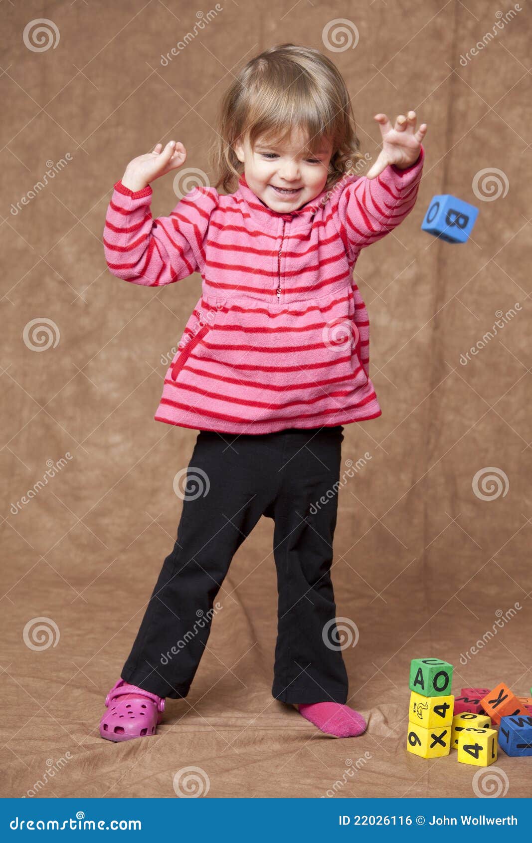 Little girl throwing block stock photo. Image of baby - 22026116