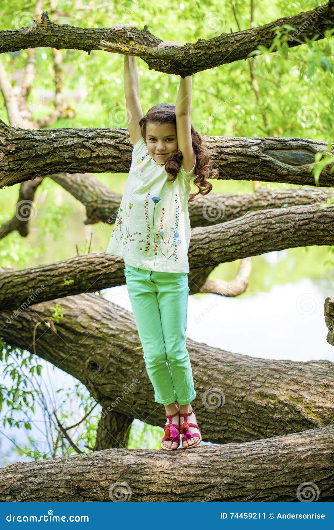 Little Girl on tree trunk stock image. Image of beautiful - 74459211