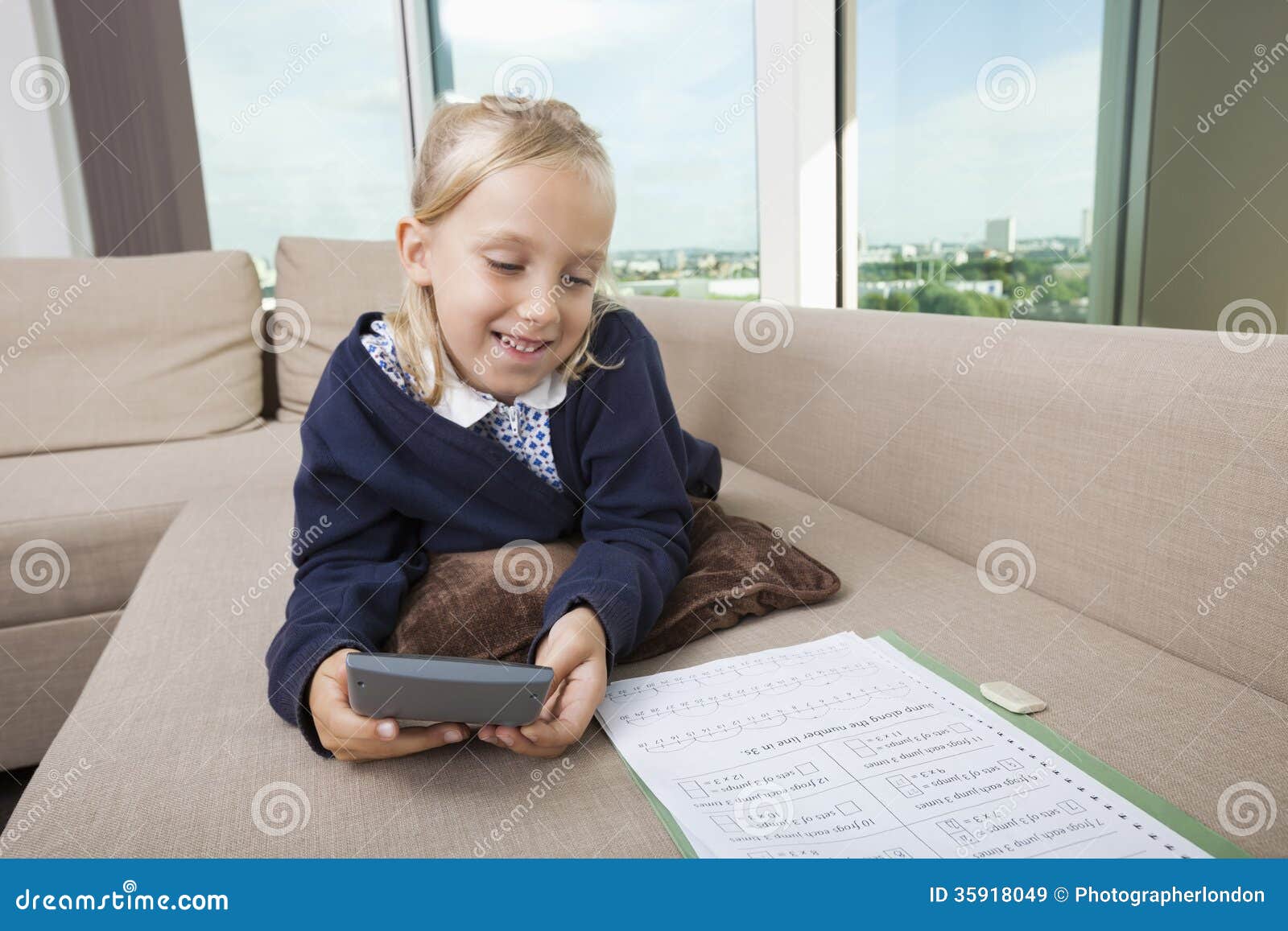 Little Girl Using Calculator while Studying on Sofa Stock Image - Image ...