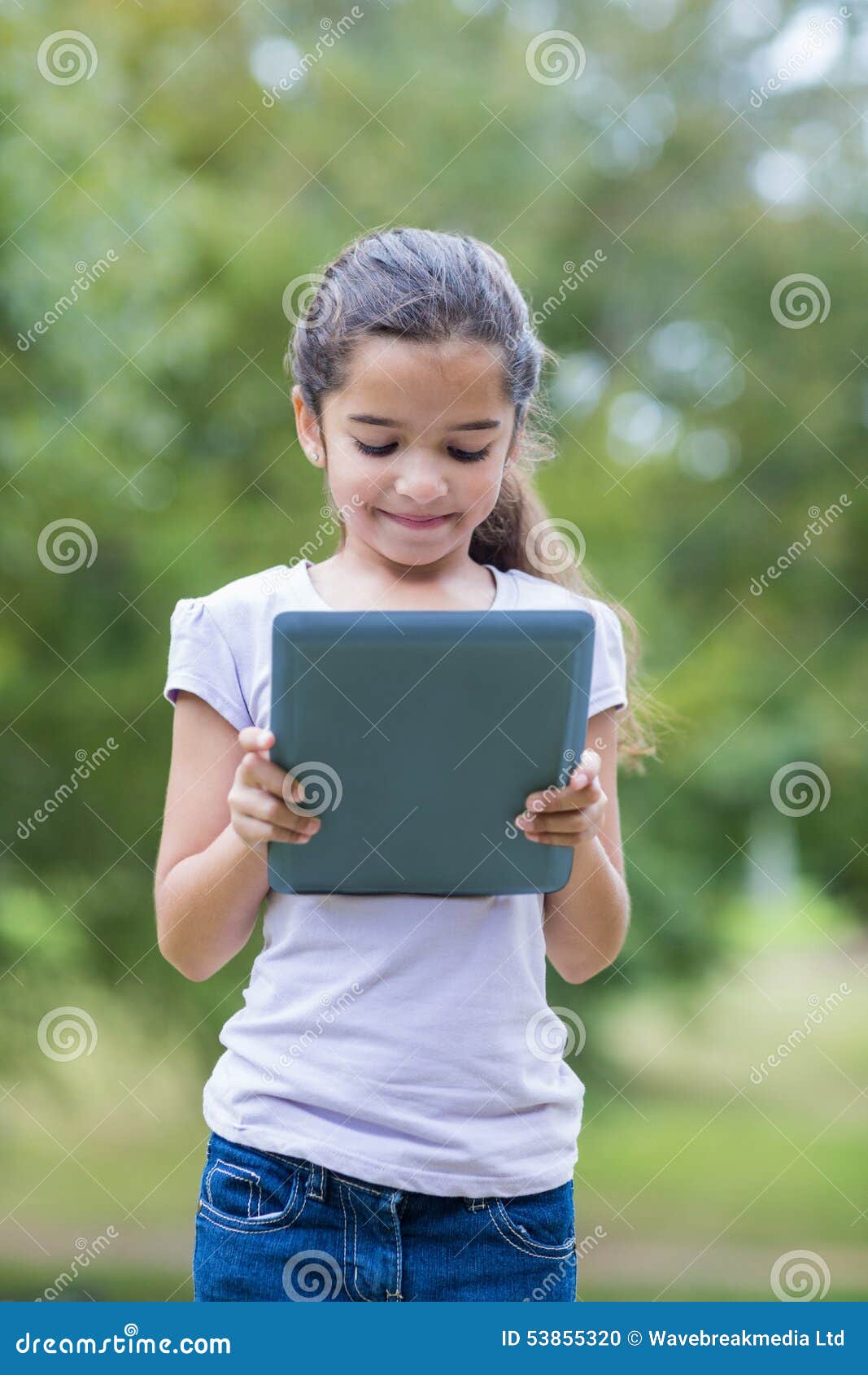 Little Girl Using Her Tablet Stock Photo - Image of female, nature ...