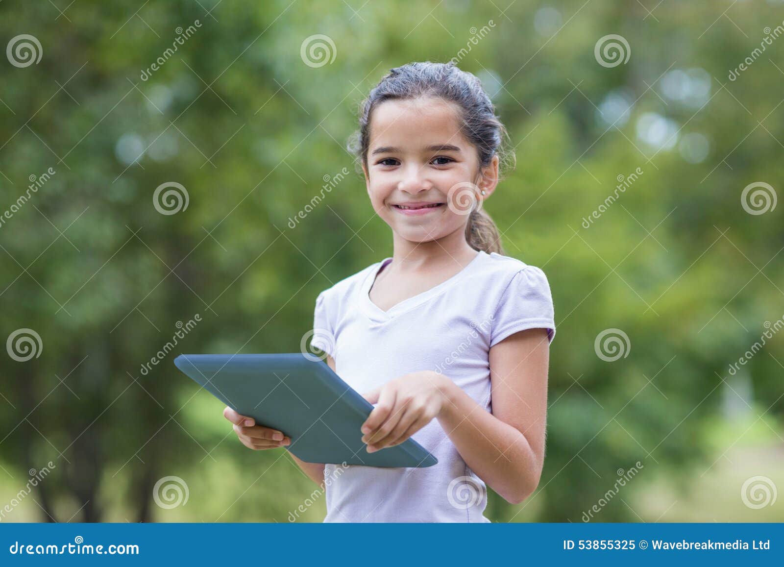 Little Girl Using Her Tablet Stock Image - Image of cute, park: 53855325