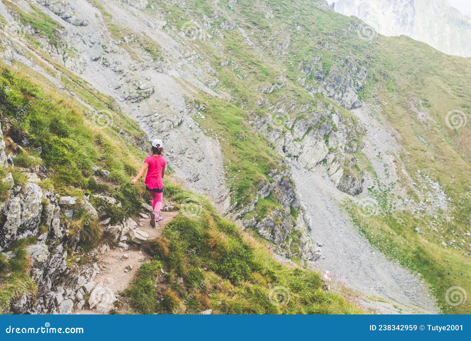 Little Girl Walking Alone on a Path on Top of a Mountain Stock Image ...