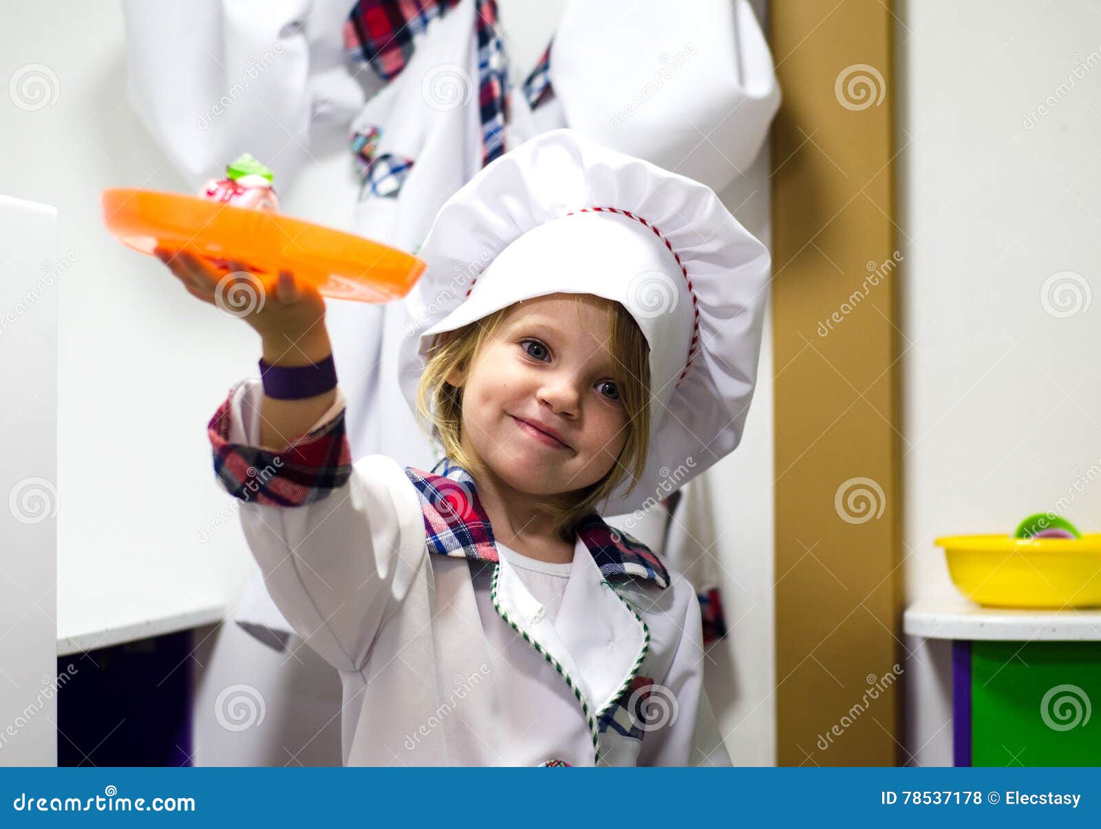 Little Girl in White Cooking Clothes Playing with Plate Stock Photo ...
