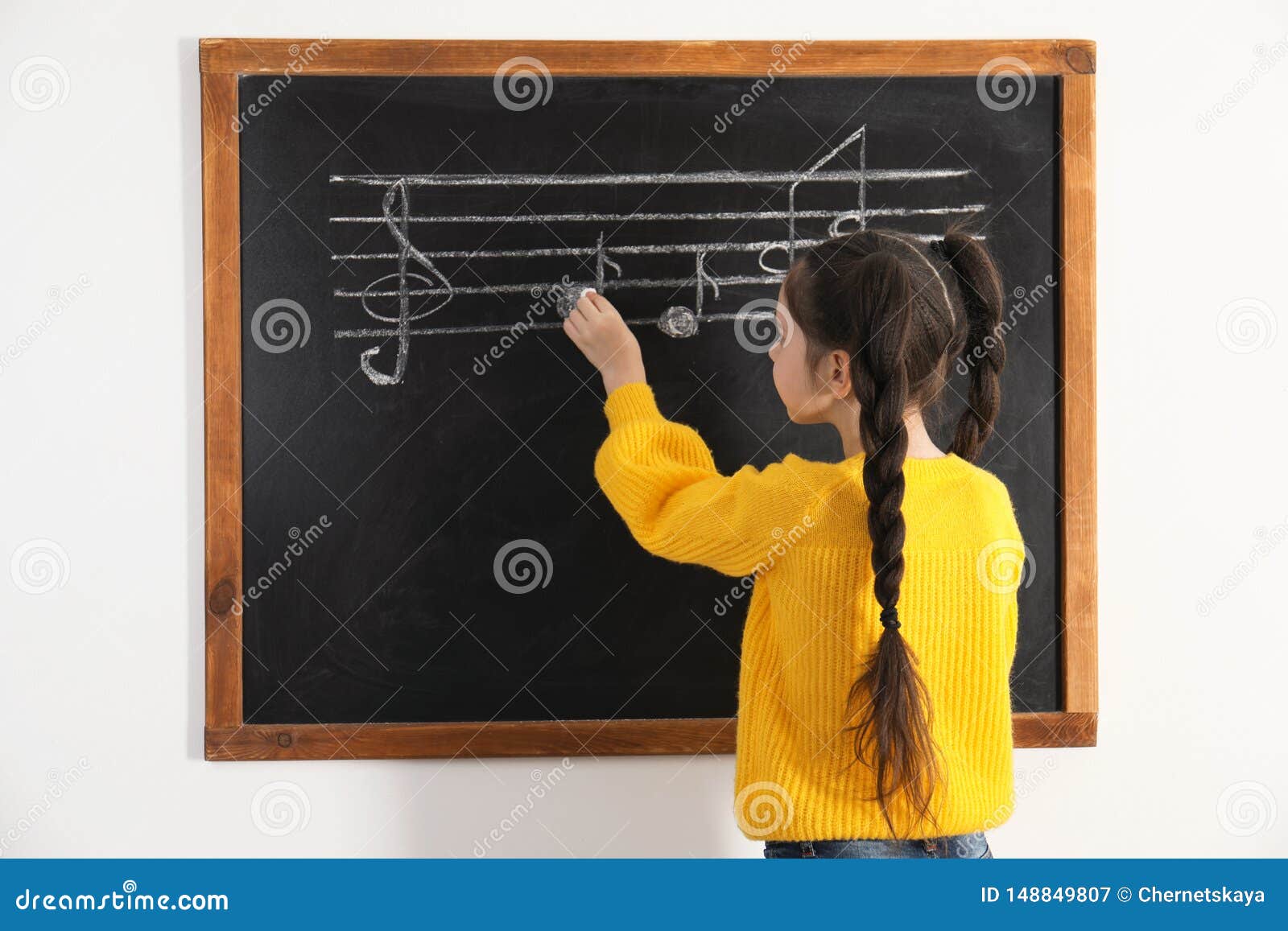 Little Girl Writing Music Notes on Blackboard Stock Image - Image of ...