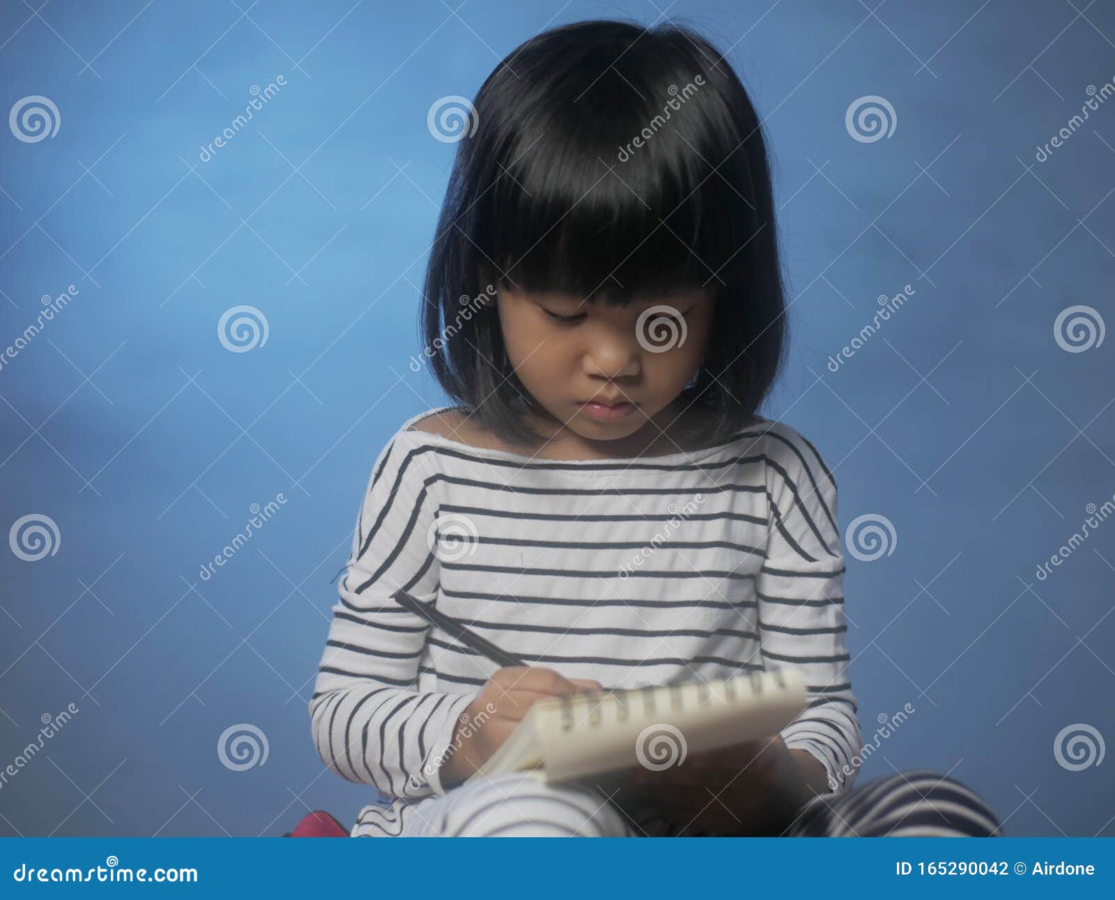 Little Girl Writing on Notepad Stock Photo - Image of enjoy, childhood ...
