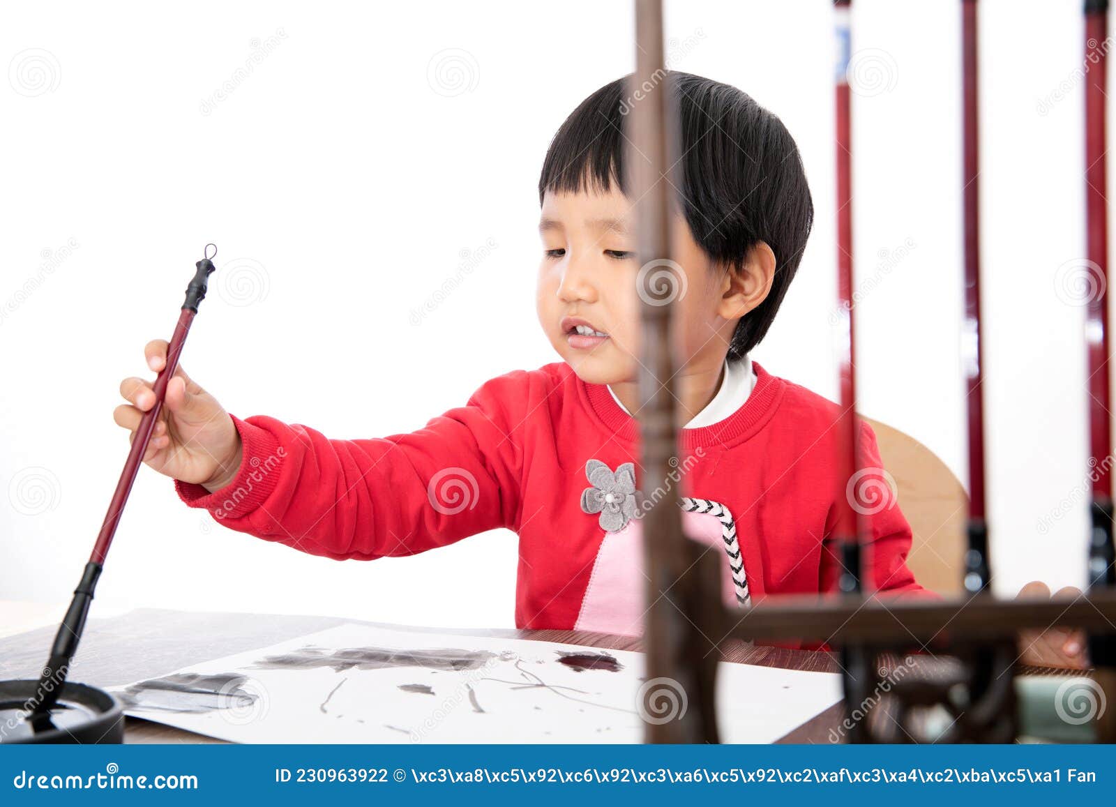 A Little Girl with Yellow Skin Practicing Calligraphy Stock Photo ...
