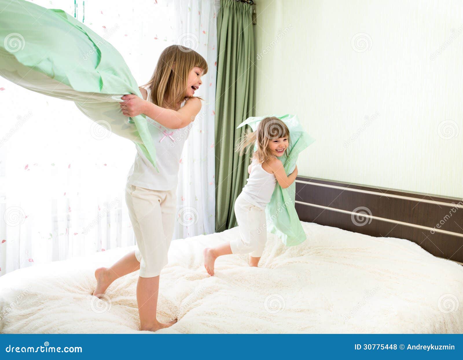 Little Girls Fighting with Pillows in Bedroom Stock Photo - Image of ...