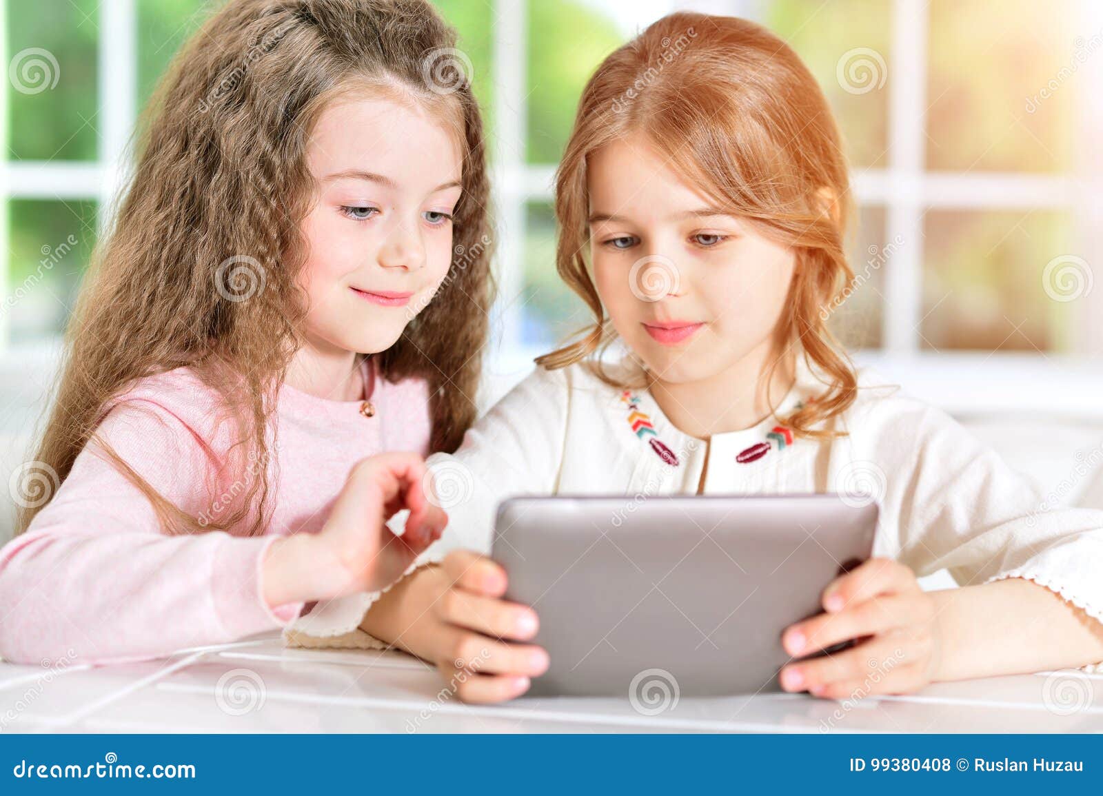 Little girls using tablet stock photo. Image of vitality - 99380408
