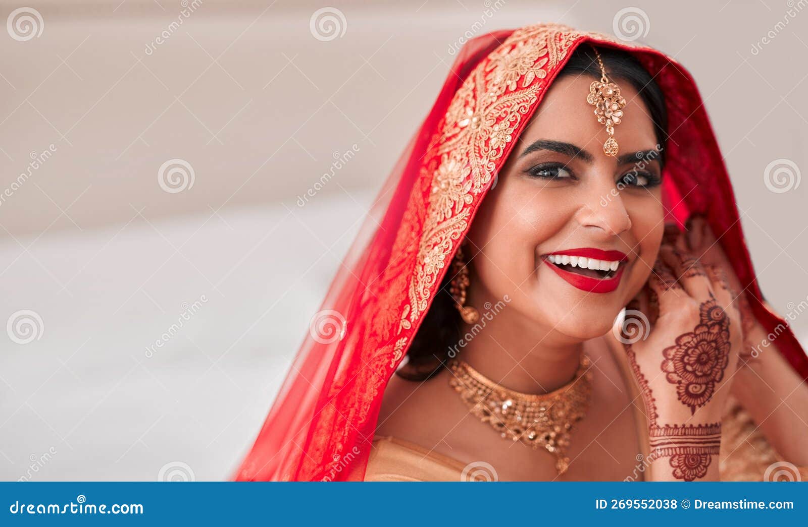 A Little Gold For That Extra Glow A Beautiful Young Woman Putting On Her Earrings In