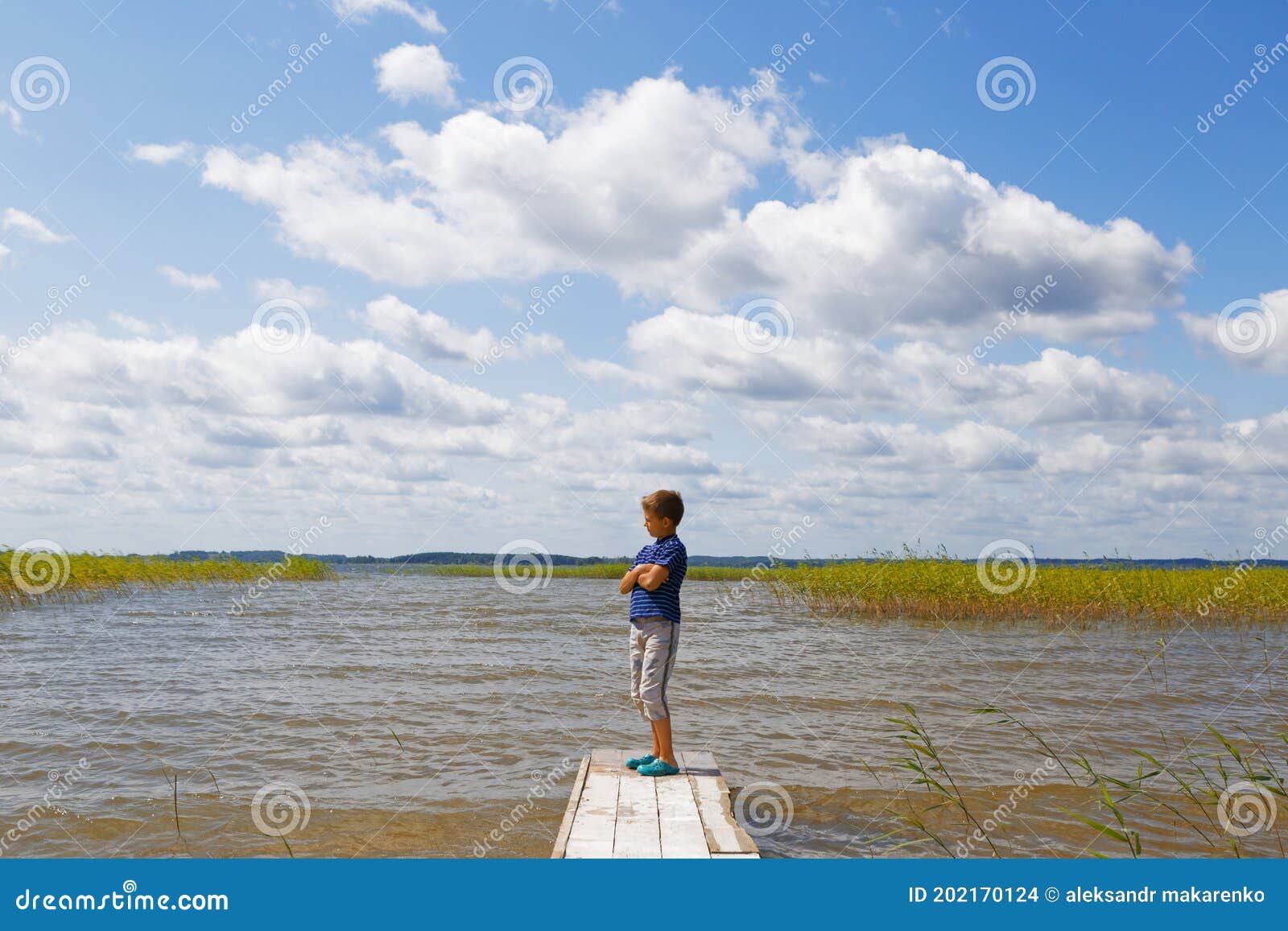 Little Kid Alone on a Wooden Lake Pier Stock Photo - Image of clouds ...