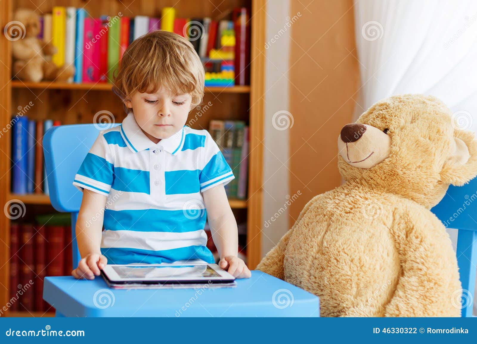 Little Kid Boy Playing with Tablet Computer in His Room at Home Stock ...