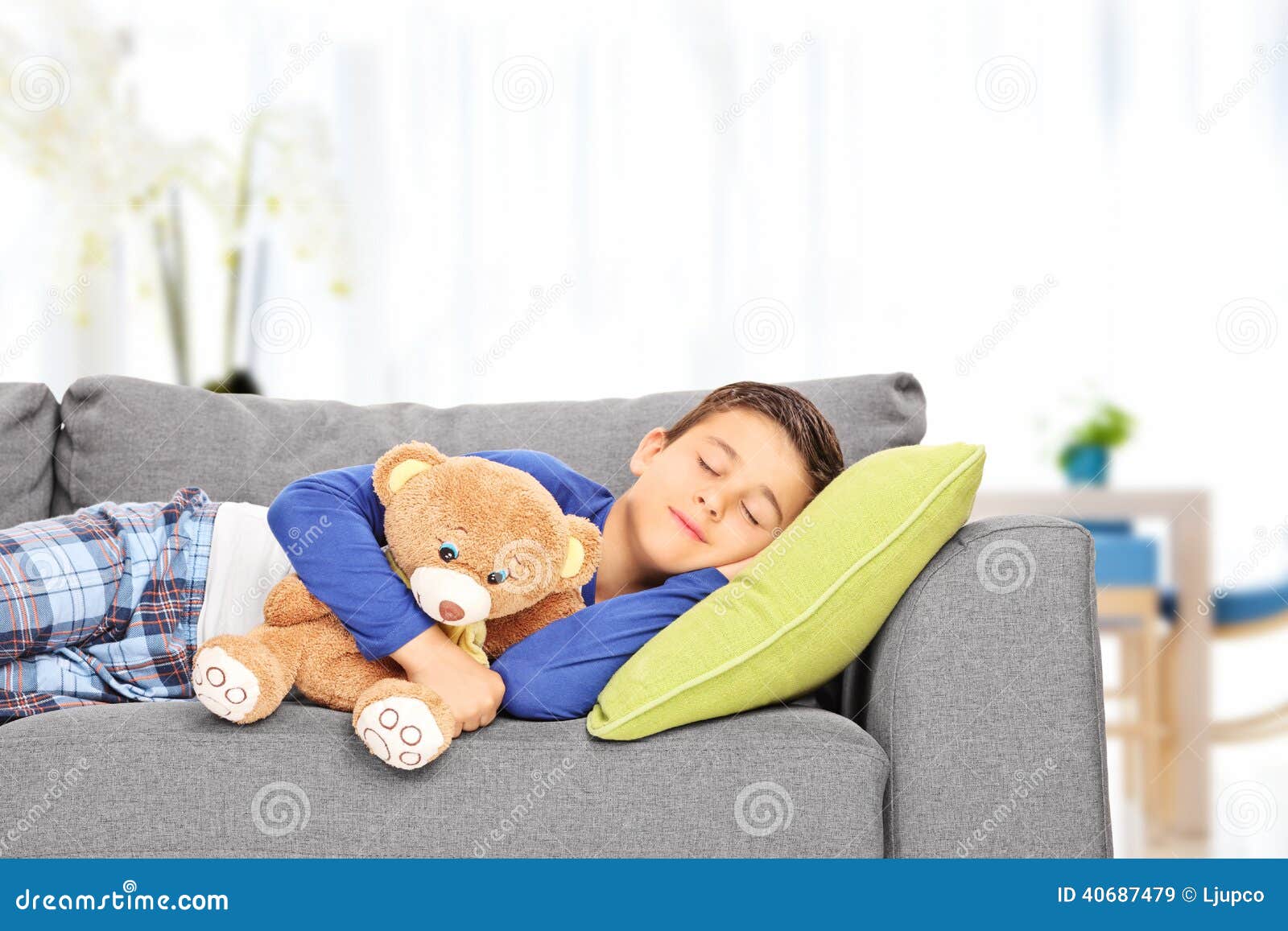 Little Kid Sleeping on Sofa with a Teddy Bear at Home Stock Image ...