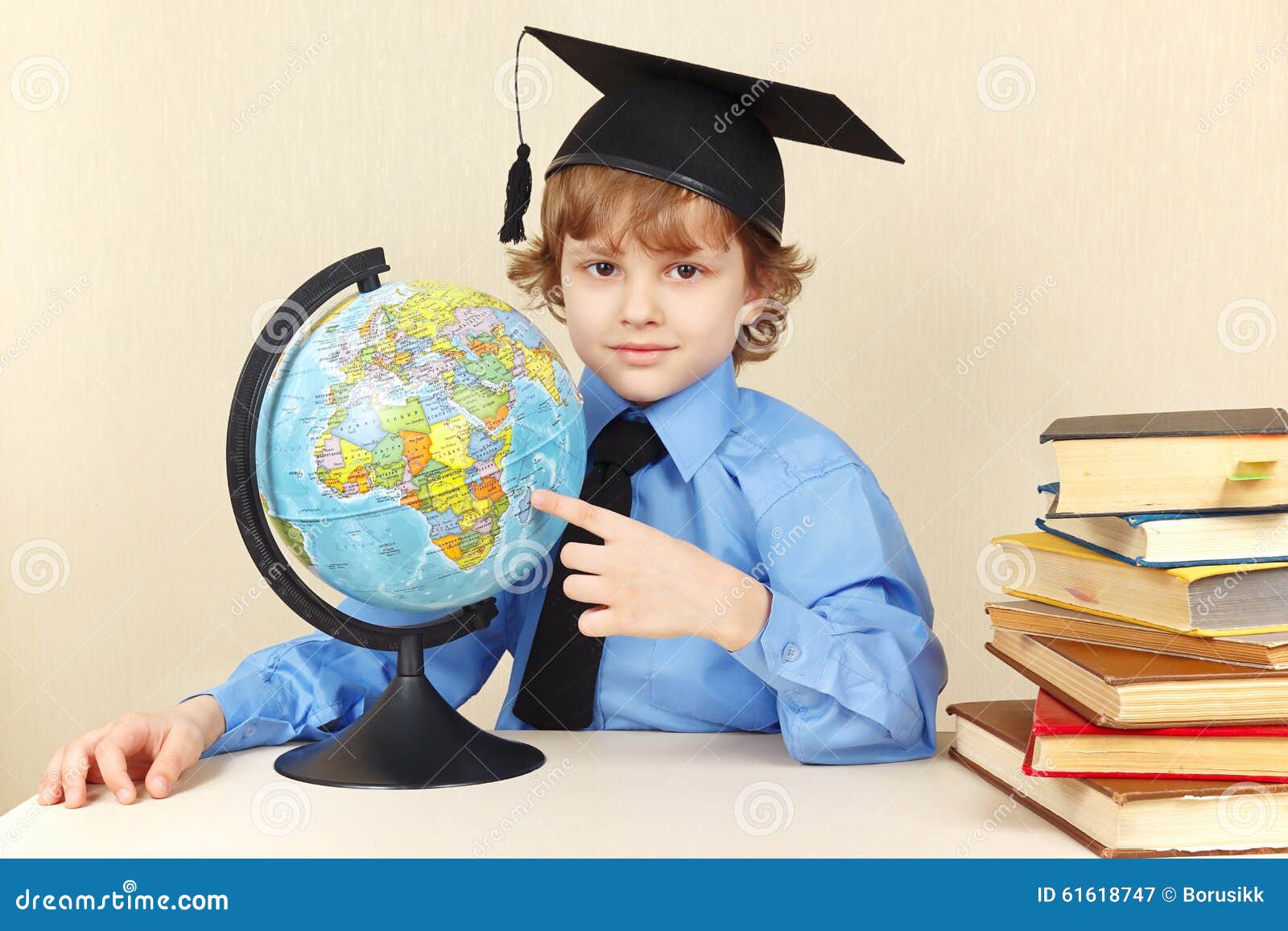 Little Professor in Academic Hat Showing on the Globe among Old Books ...