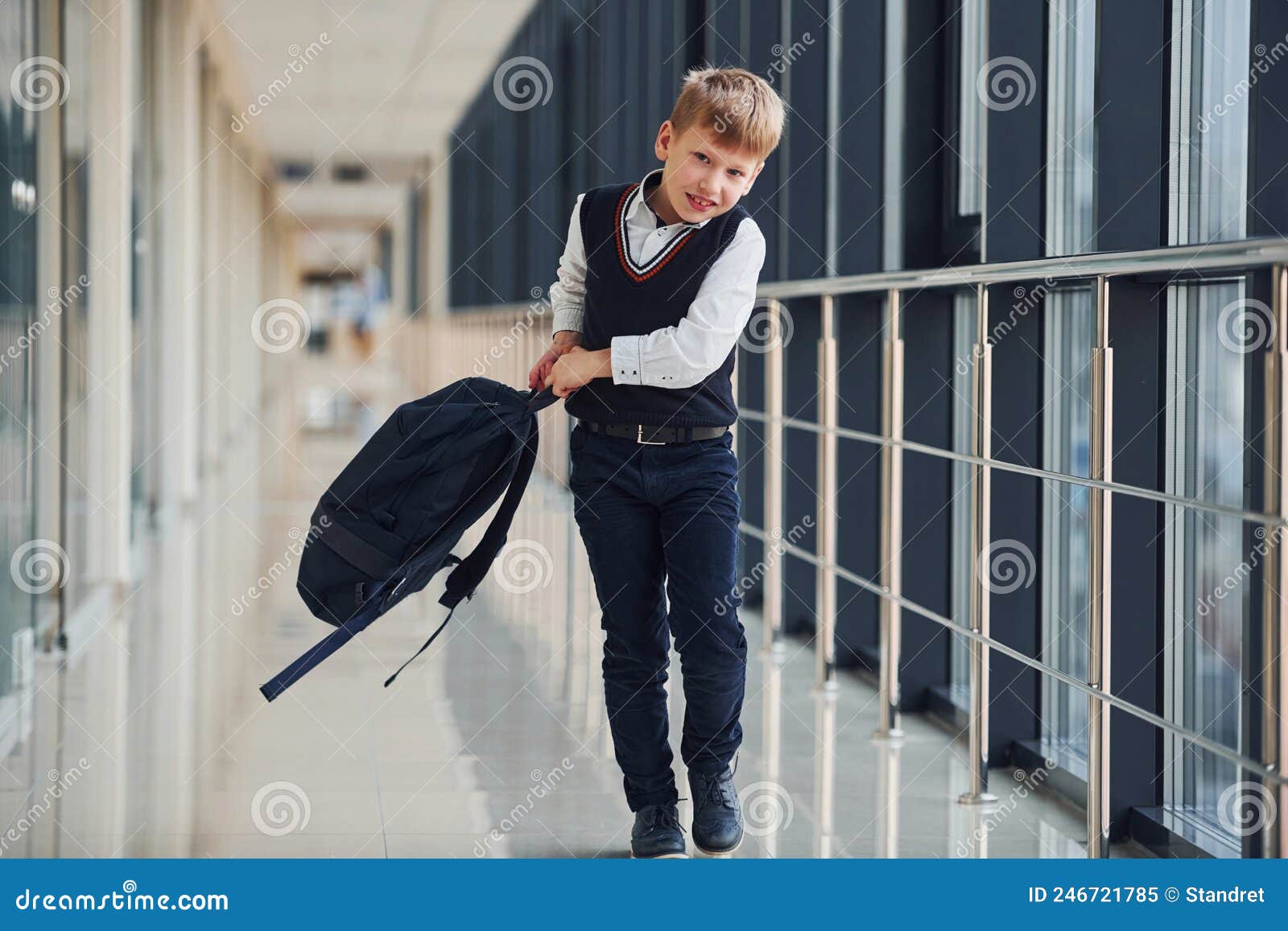 Little School Boy in Uniform Walking in Corridor with Backpack Stock ...