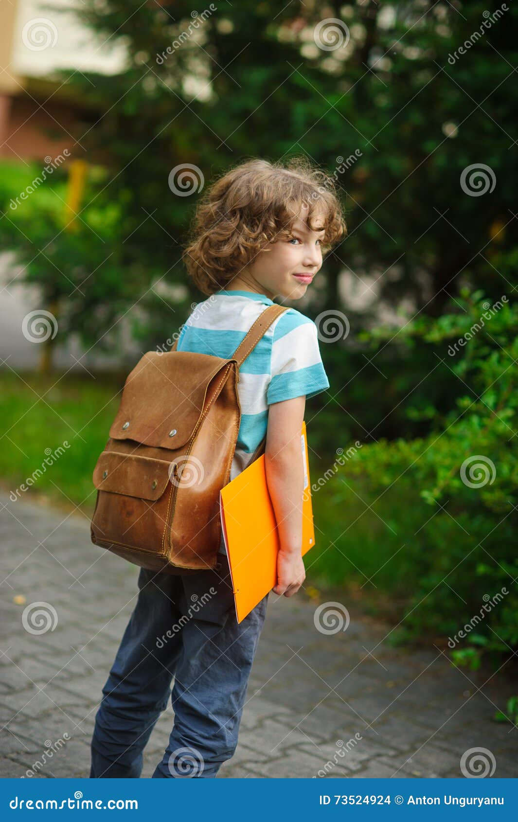 Little Schoolboy with a School Backpack Behind the Back. Stock Photo ...
