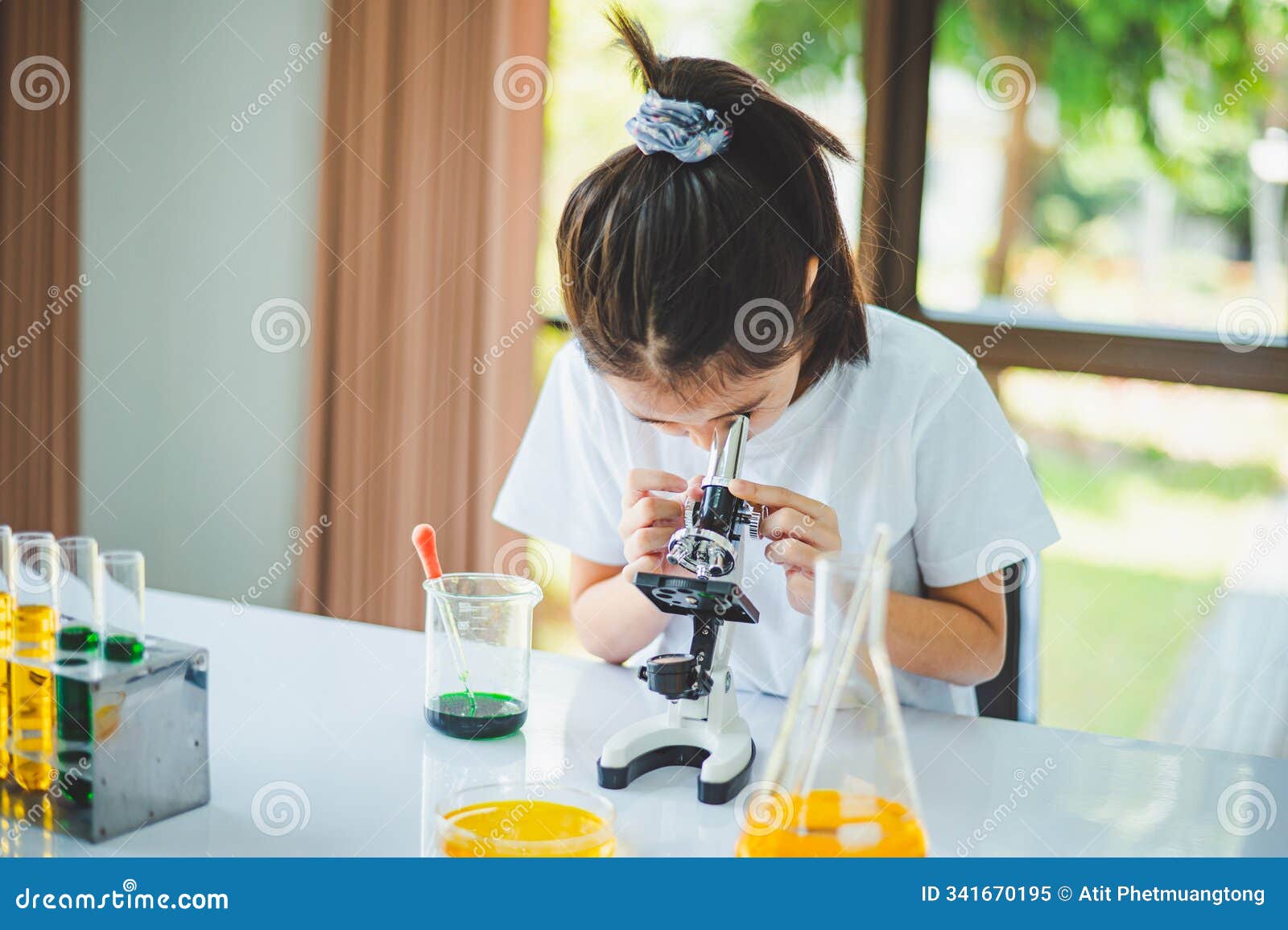 Little Scientist Looking through a Microscope and Test Tubes Filled ...