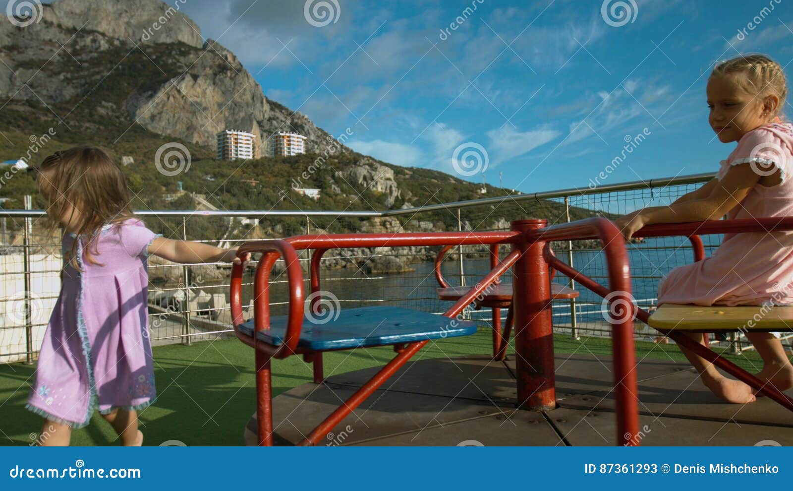 Little Sisters Spinning On The Carousel Outdoors Royalty-Free Stock ...