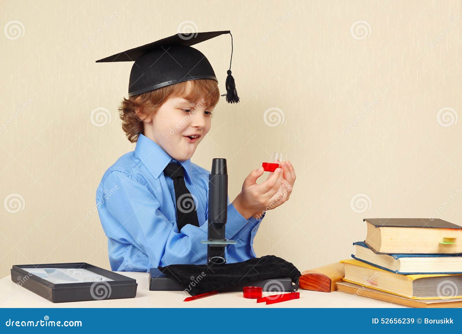 Little Smiling Boy in Academic Hat Sees the Results of Research Next To ...