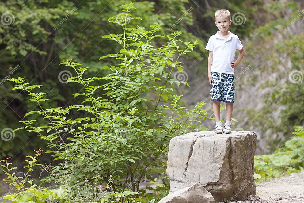 Little Smiling Boy Standing on a Big Stone Stock Photo - Image of ...
