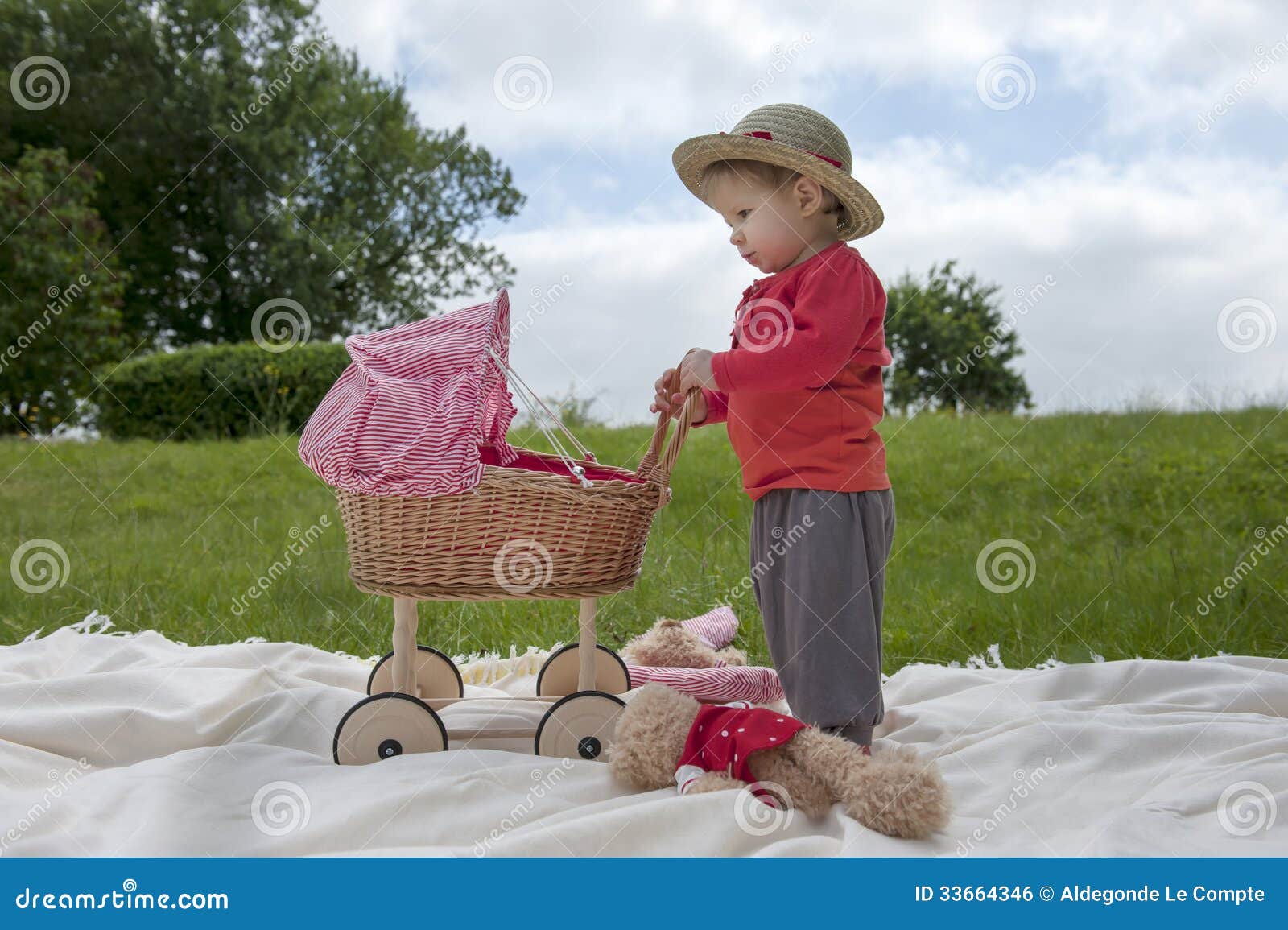 Little Toddler Playing with a Pram Outdoors Stock Photo - Image of ...